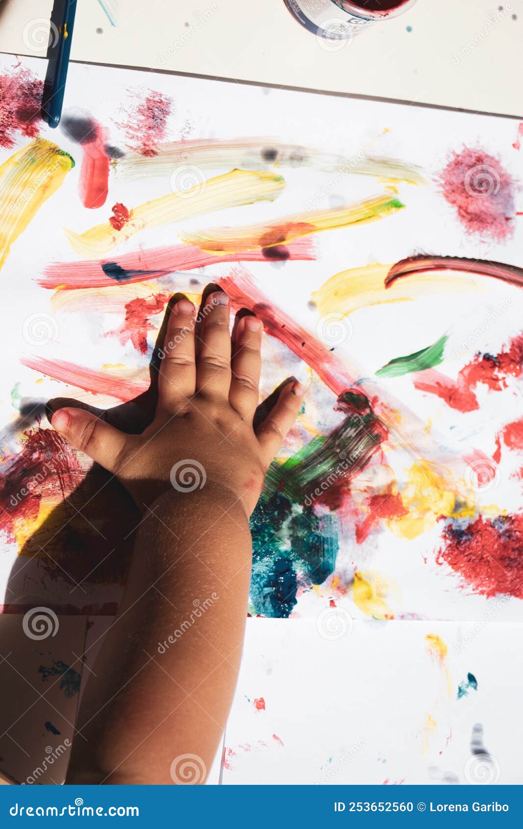 Child S Hand Making His Mark on Paper Painted with Tempera Stock Photo ...