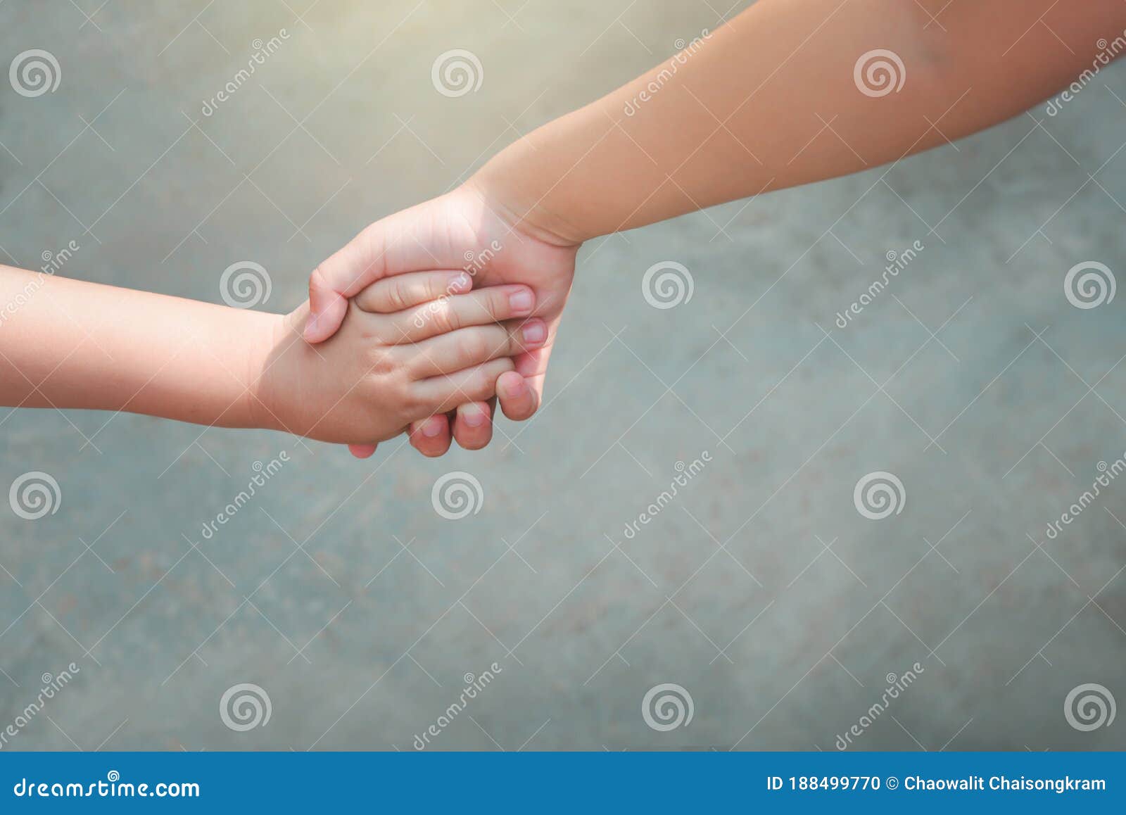 The Child`s Right Hand Helps To Pull One Hand of the Young Child Stock ...