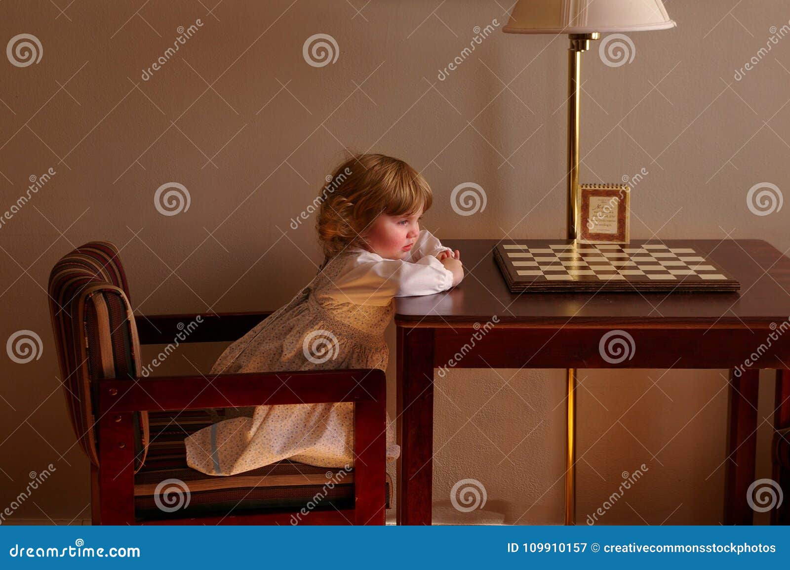 Child Setting On Chair In Front Of Table Picture. Image: 109910157