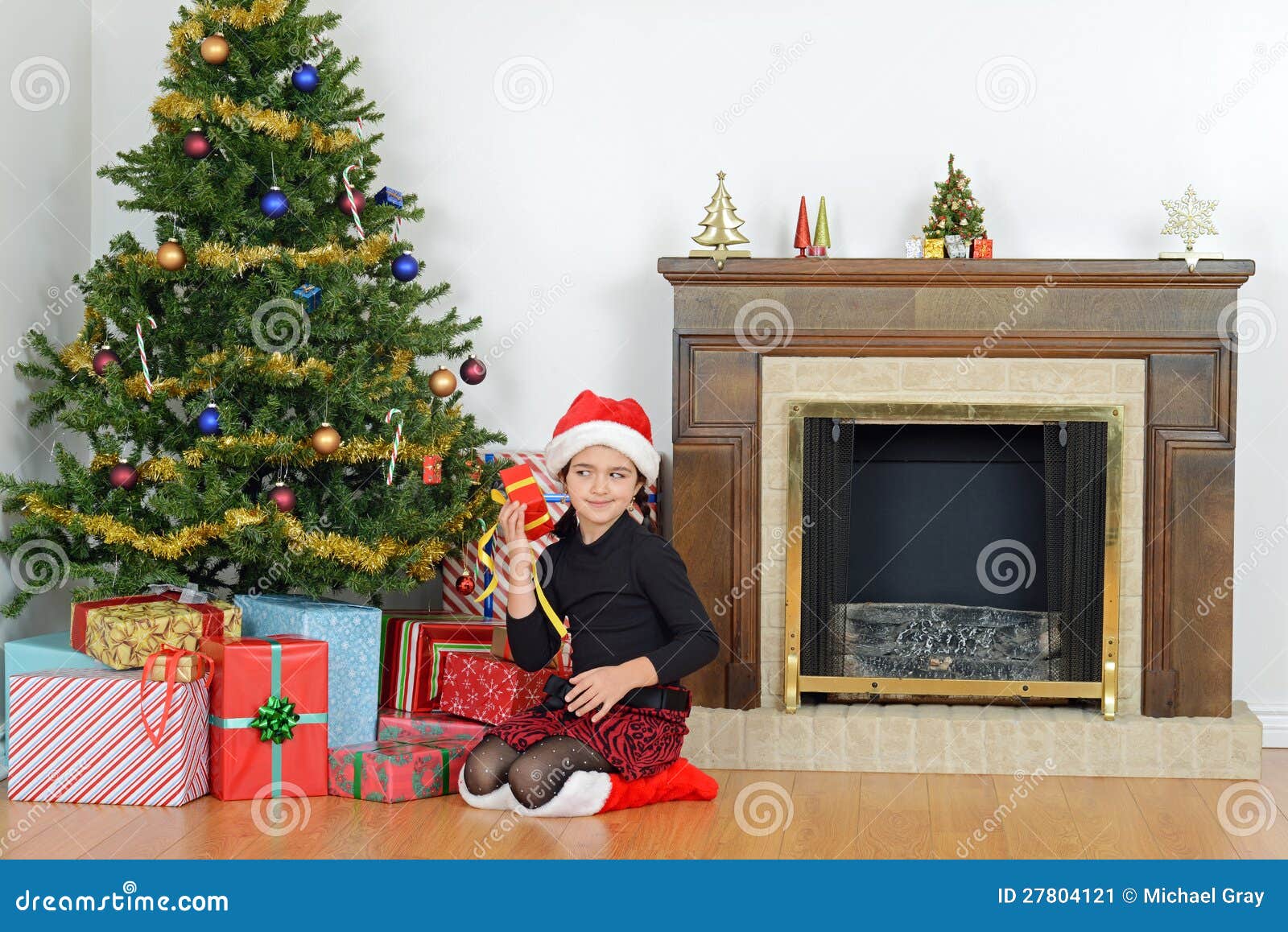 Child Shaking Christmas Present by Tree Stock Image - Image of holding ...