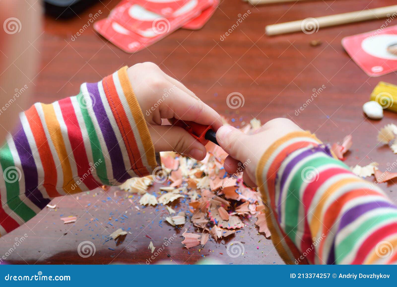 The Child Sharpens the Pencil with a Sharpener for Further Drawing with ...