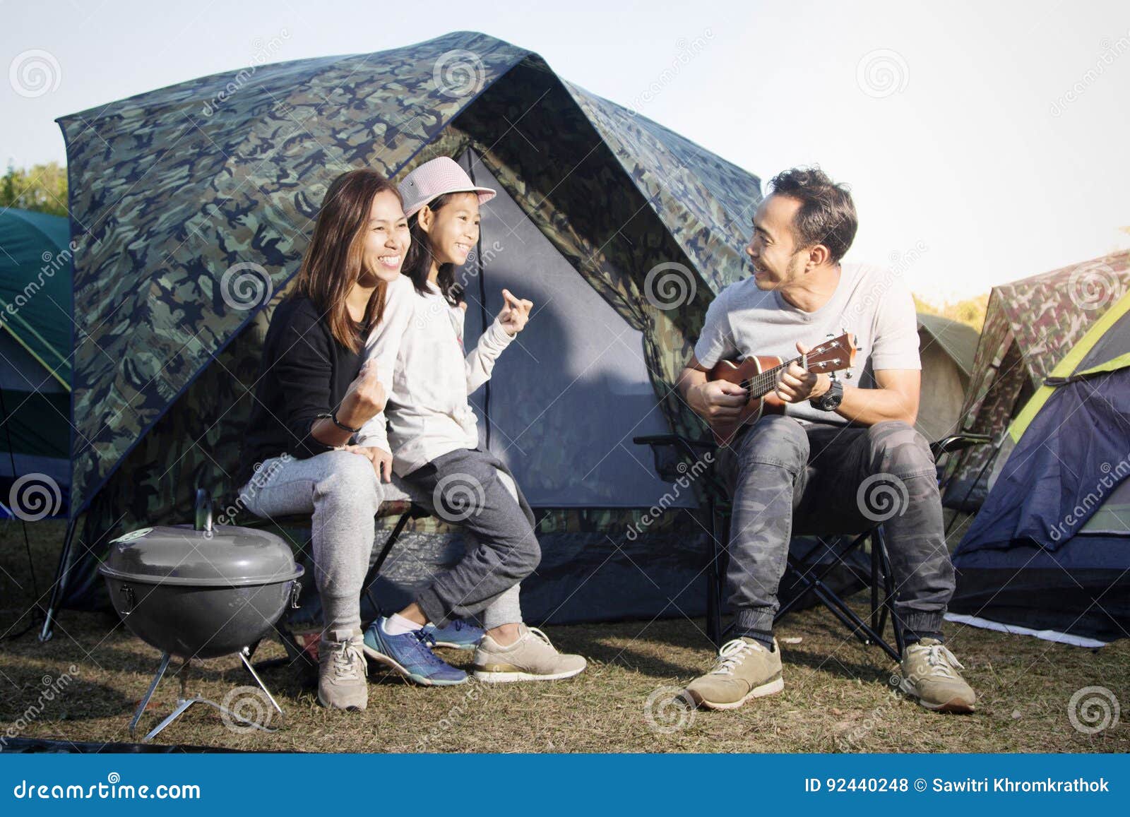Child Singing with Family on Camping Stock Photo - Image of family ...
