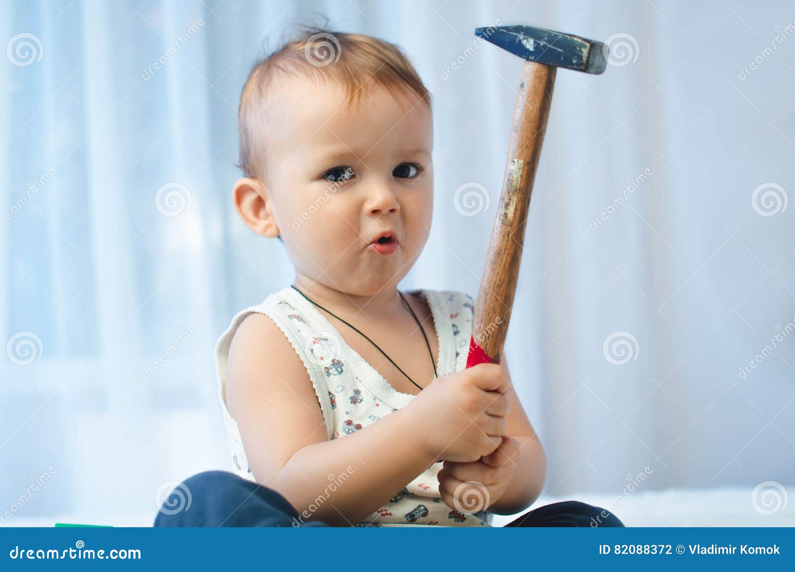 The Child Sits with a Hammer Stock Photo - Image of surprise, cute ...