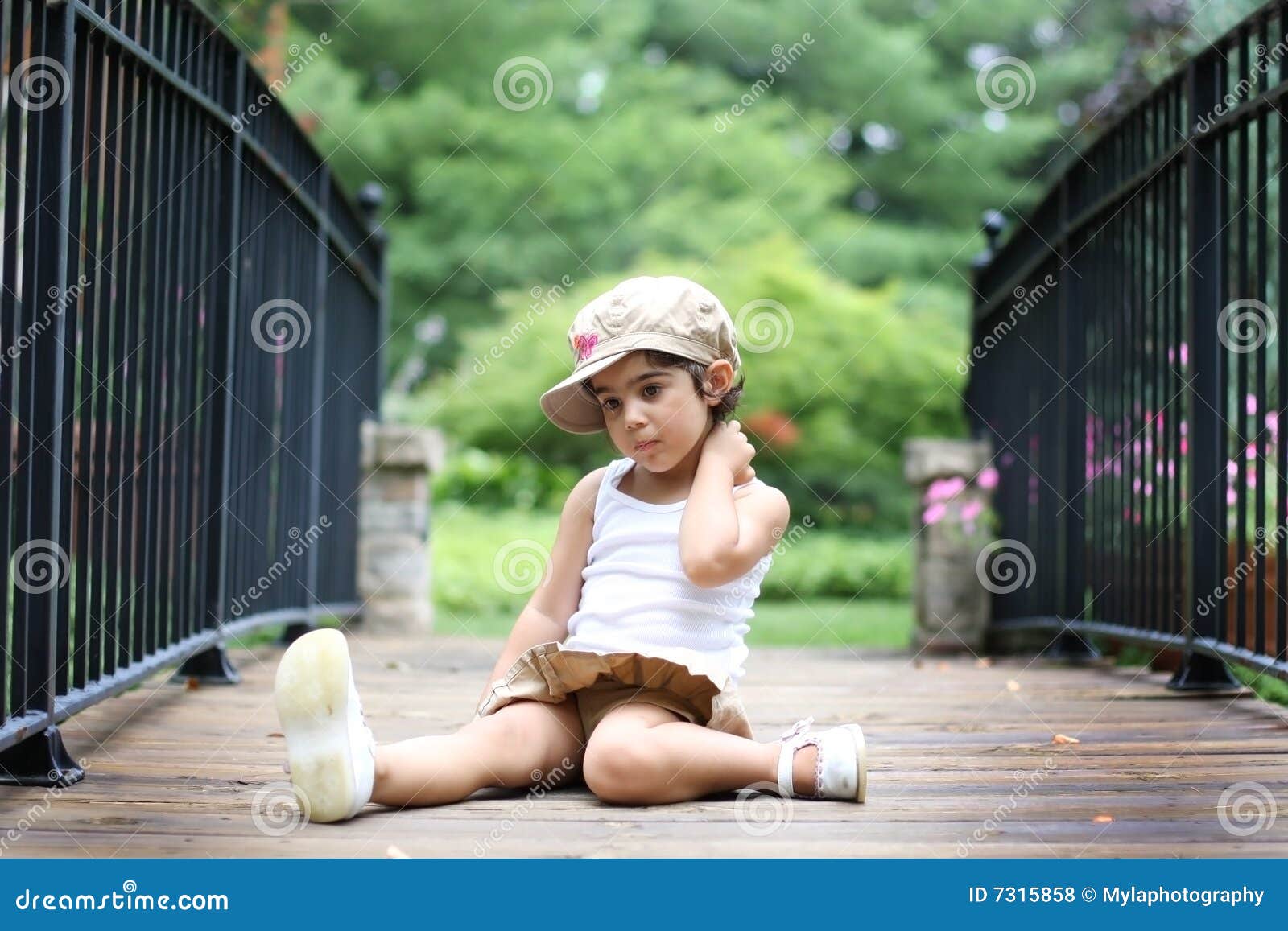 Child sitting on bridge stock photo. Image of cute, rails - 7315858