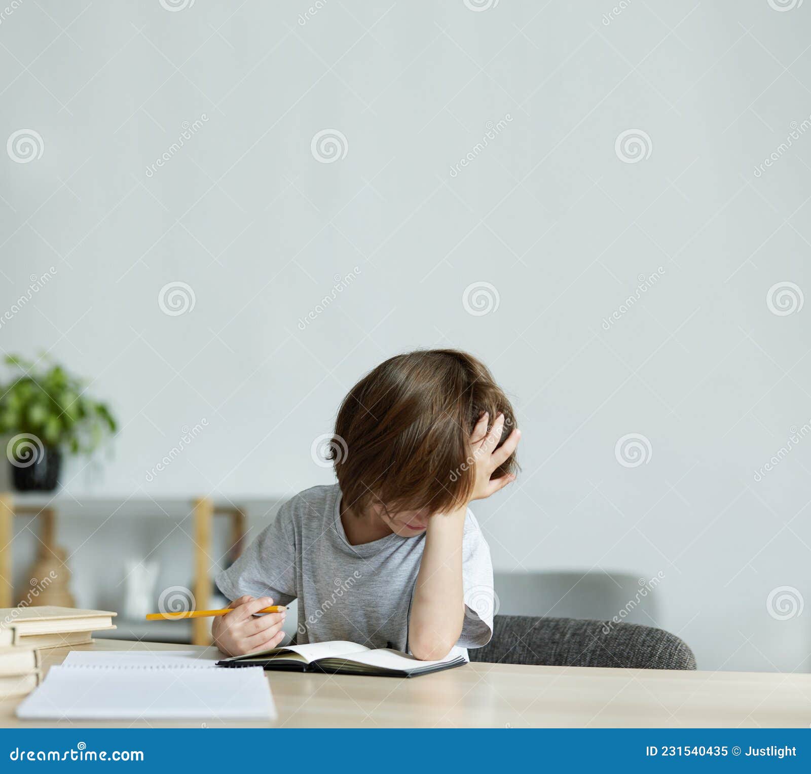 Child Sitting at the Desk, Exhausted from Homework and Learning ...