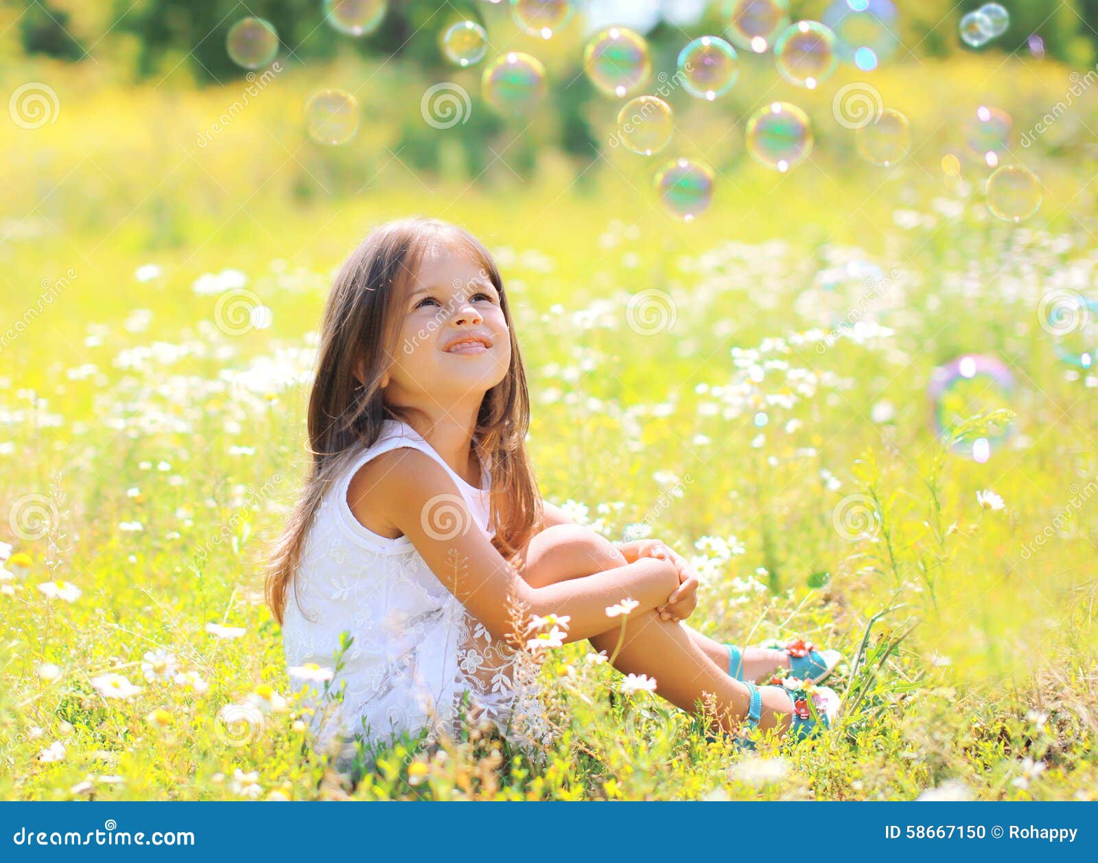Child Sitting on the Grass Dreaming in Sunny Summer Stock Photo - Image ...
