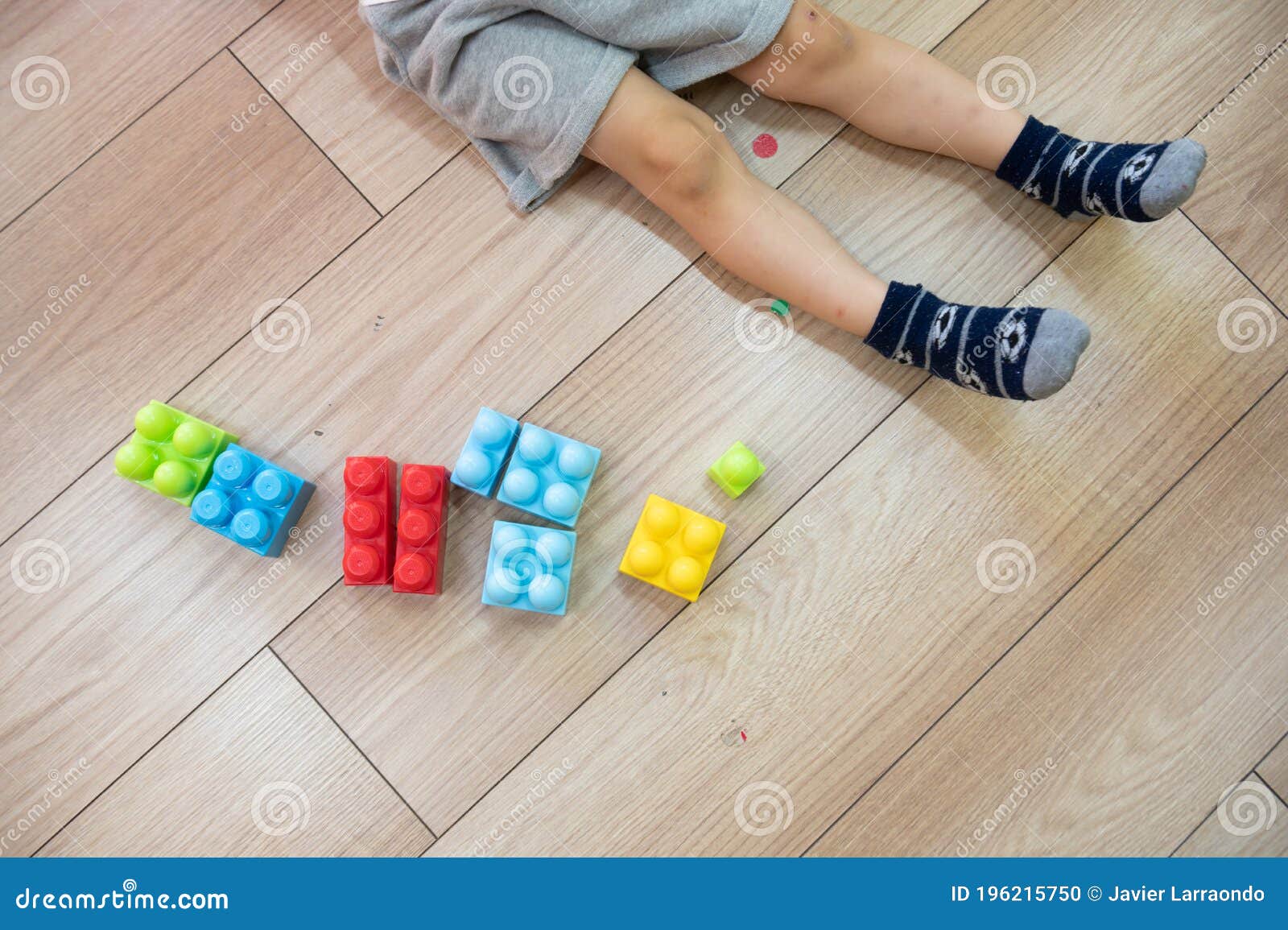 Child Sitting on the Kindergarten Floor Together with Colored Blocks ...