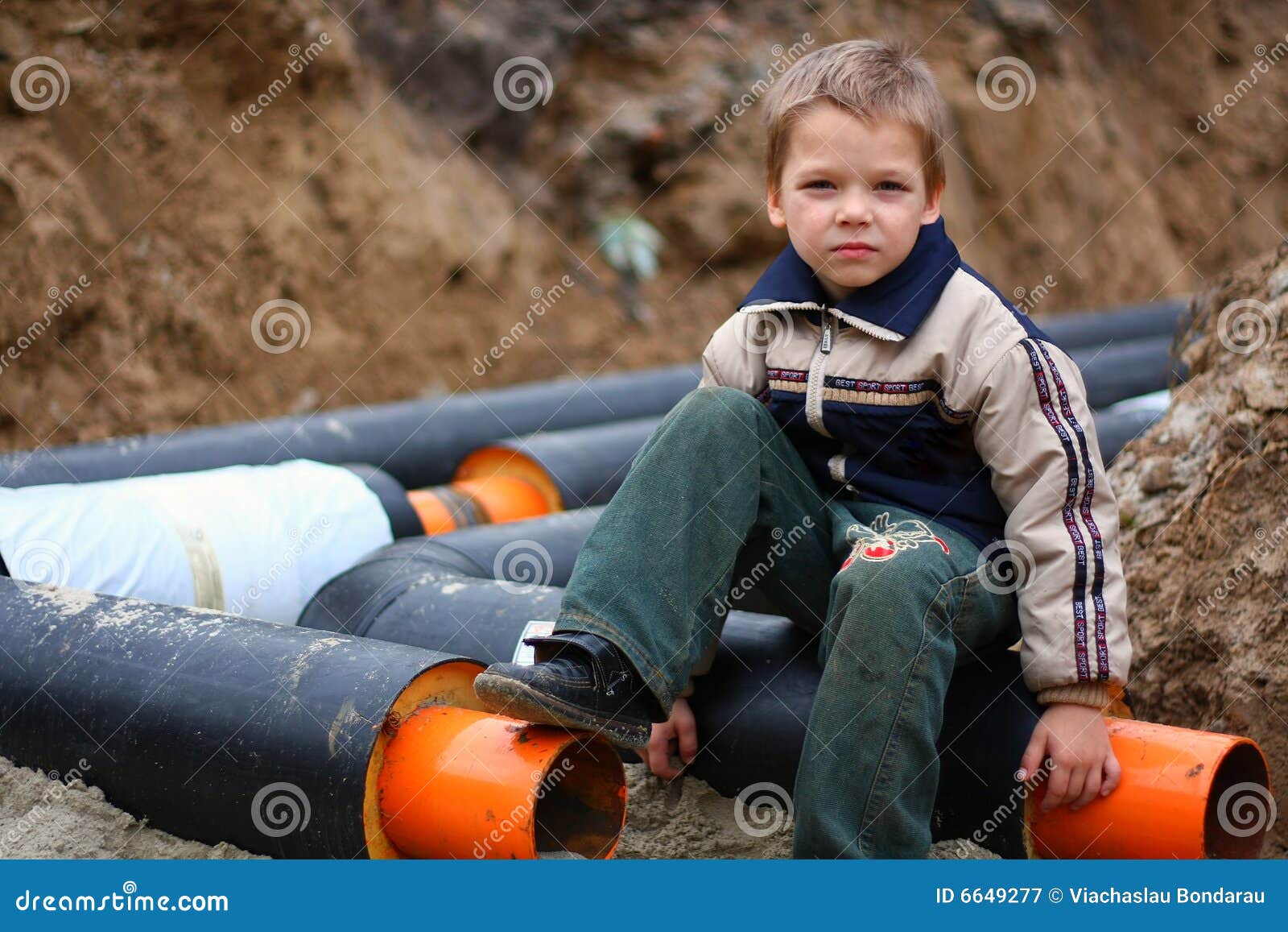 Child sitting on a pipe stock image. Image of serious - 6649277