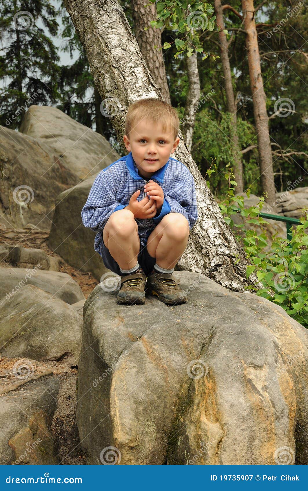 Child sitting on stone stock image. Image of tree, young - 19735907