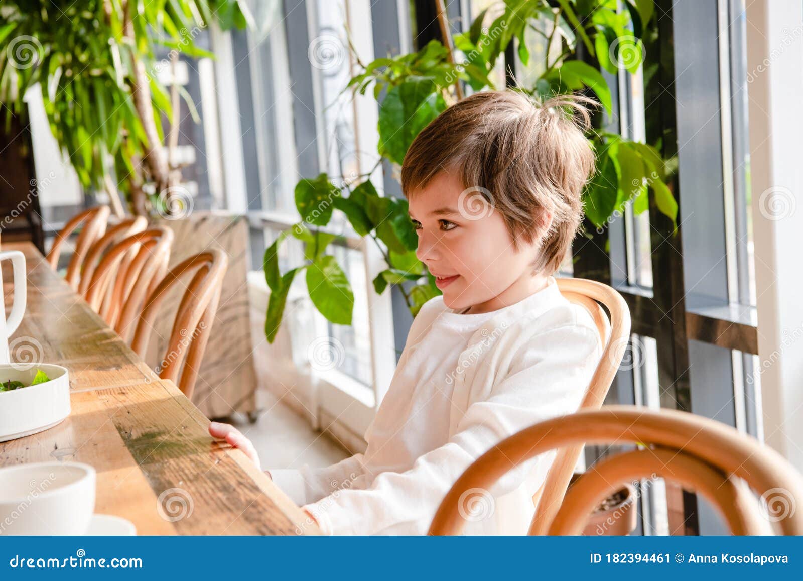 A Child Sitting at the Table and Smiling Stock Image - Image of ...