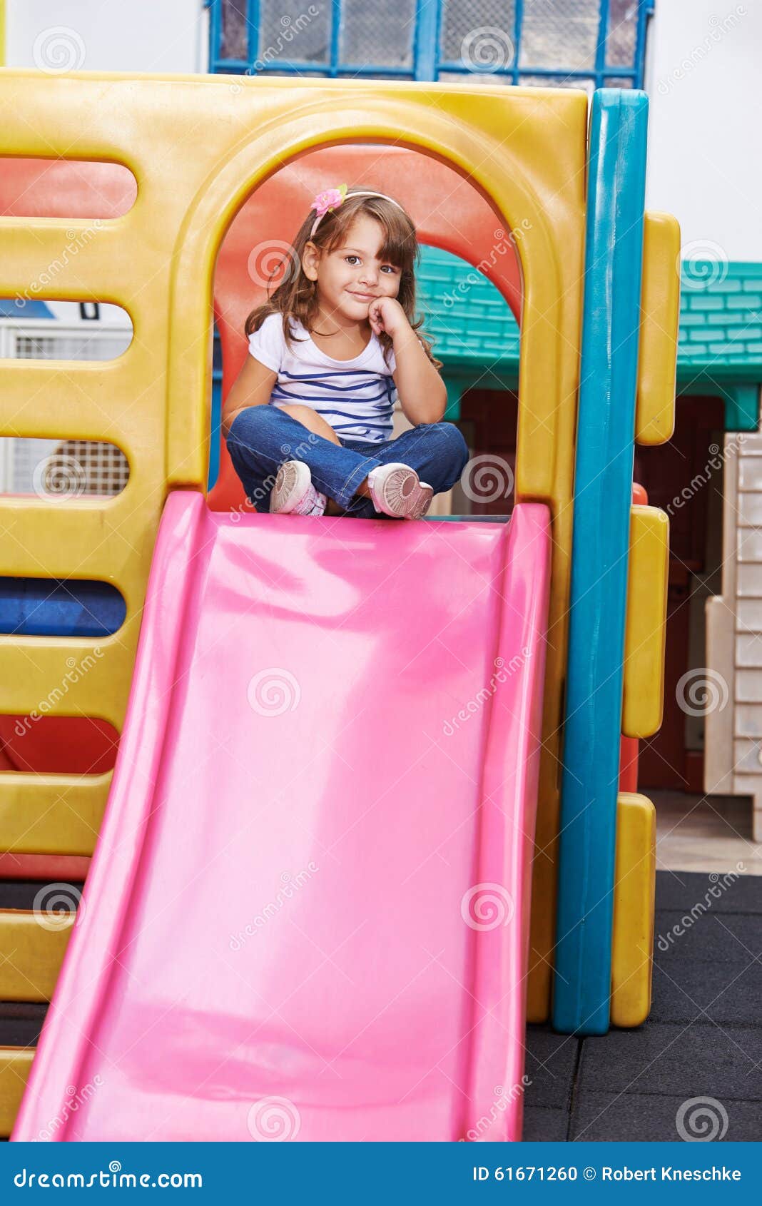 Child Sitting on Top of a Slide Stock Photo - Image of indoor, young ...