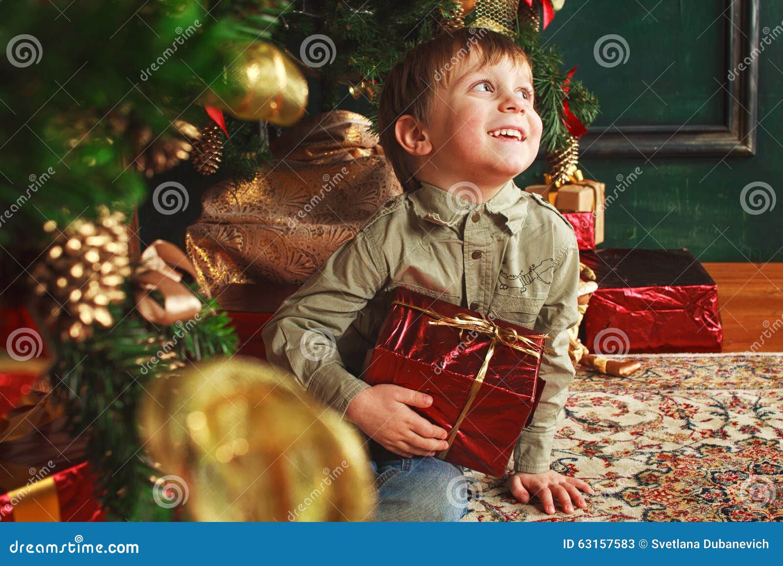 Child Sitting Under the Christmas Tree with Gifts Stock Image - Image ...