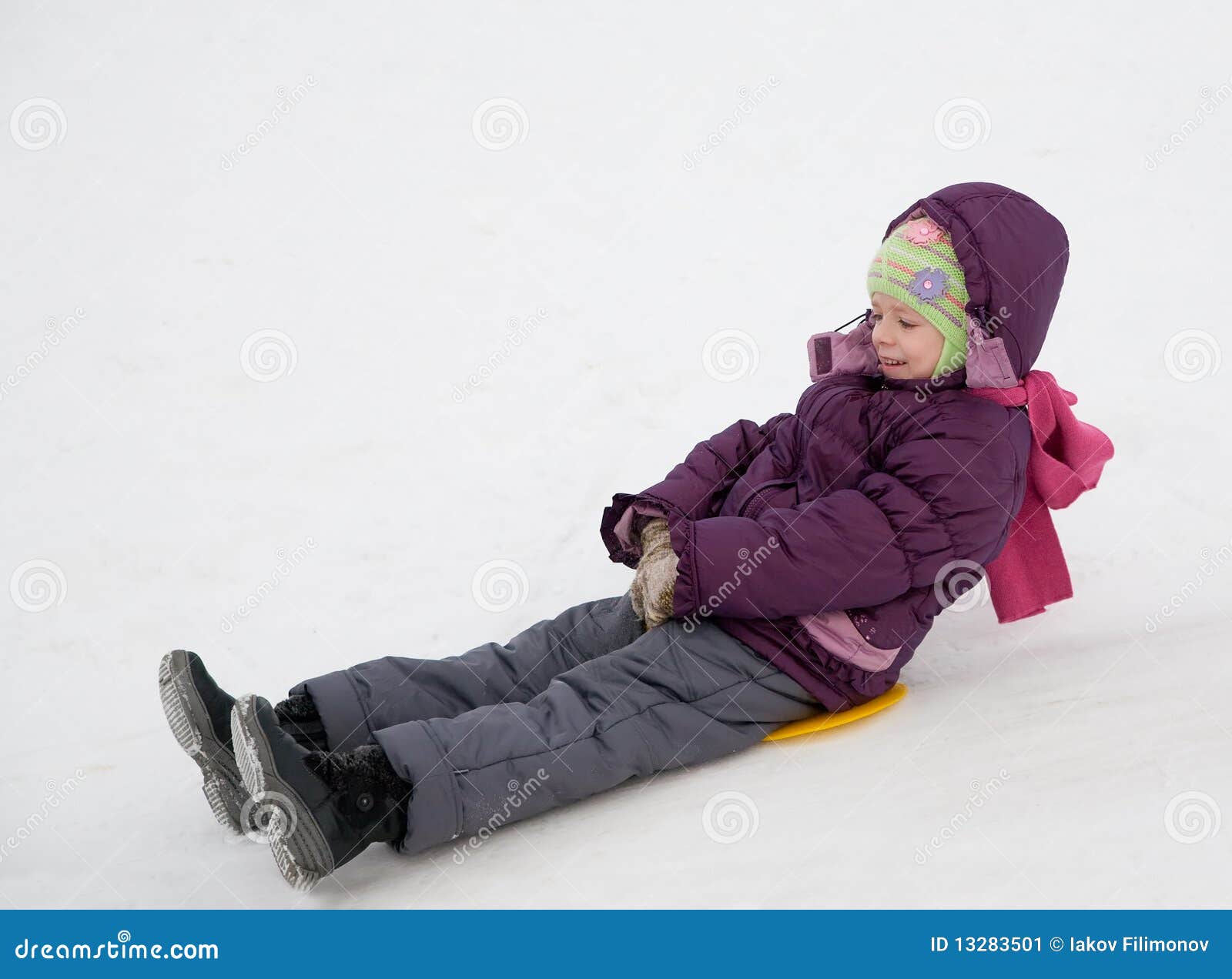 Child sliding in the snow stock image. Image of playful - 13283501