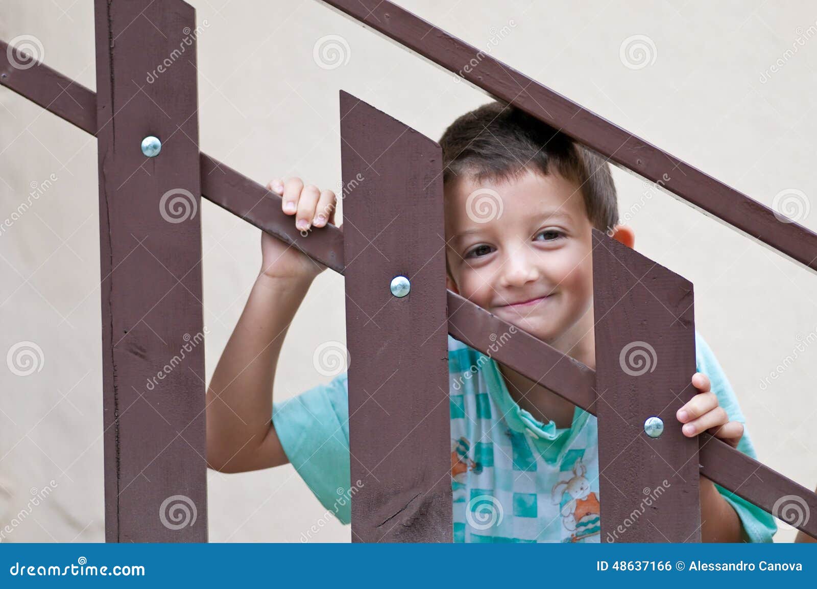 Child Smiling through a Railing Stock Photo - Image of canceled ...
