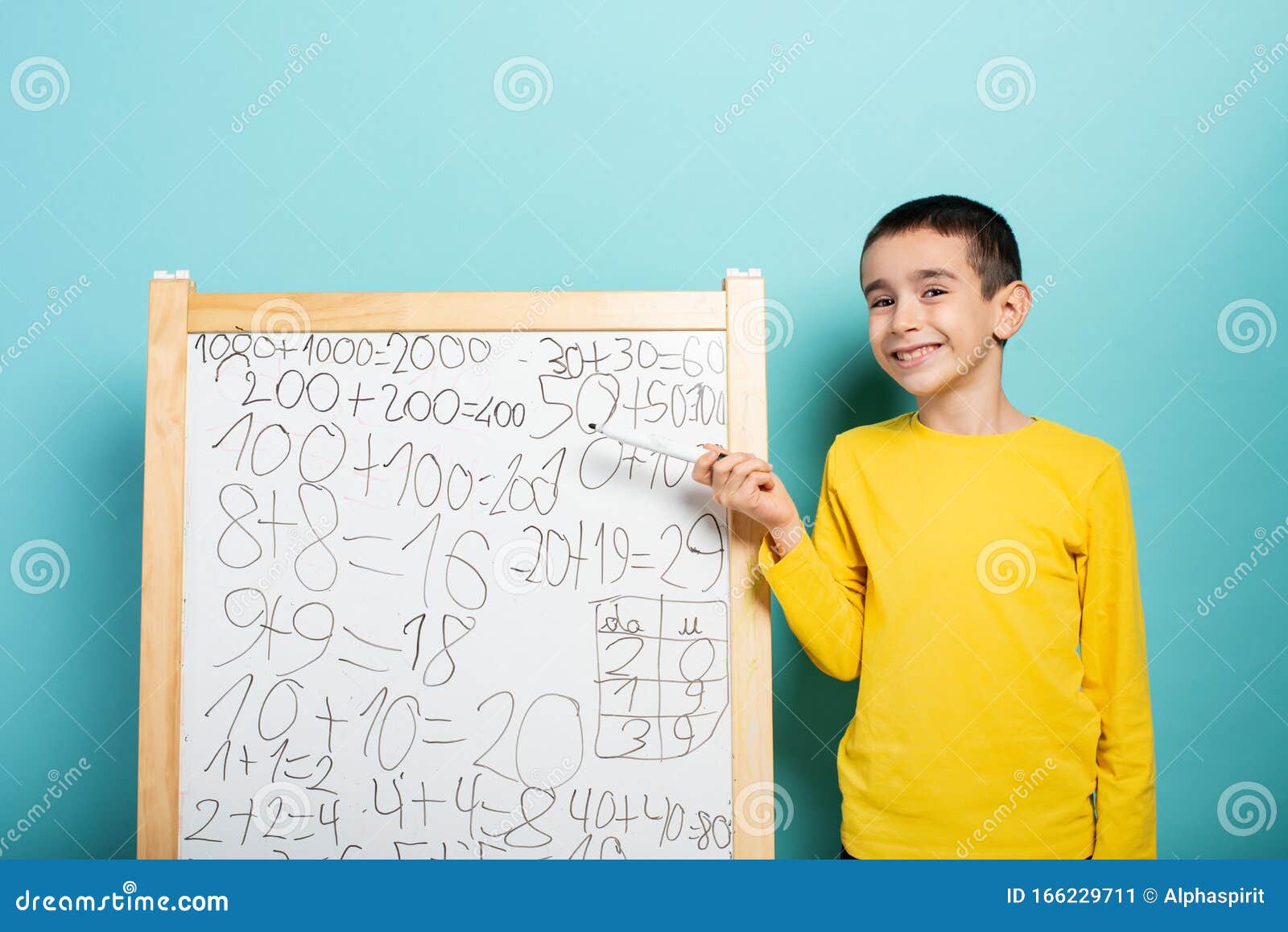 The Boy Solves Mathematical Examples. A Child Solves Examples On A ...