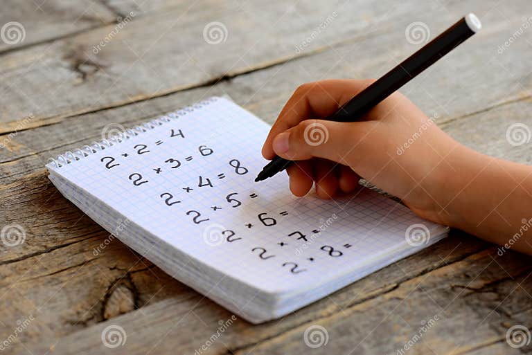 Child Solves Mathematics Examples. Child Holds a Black Marker in His ...