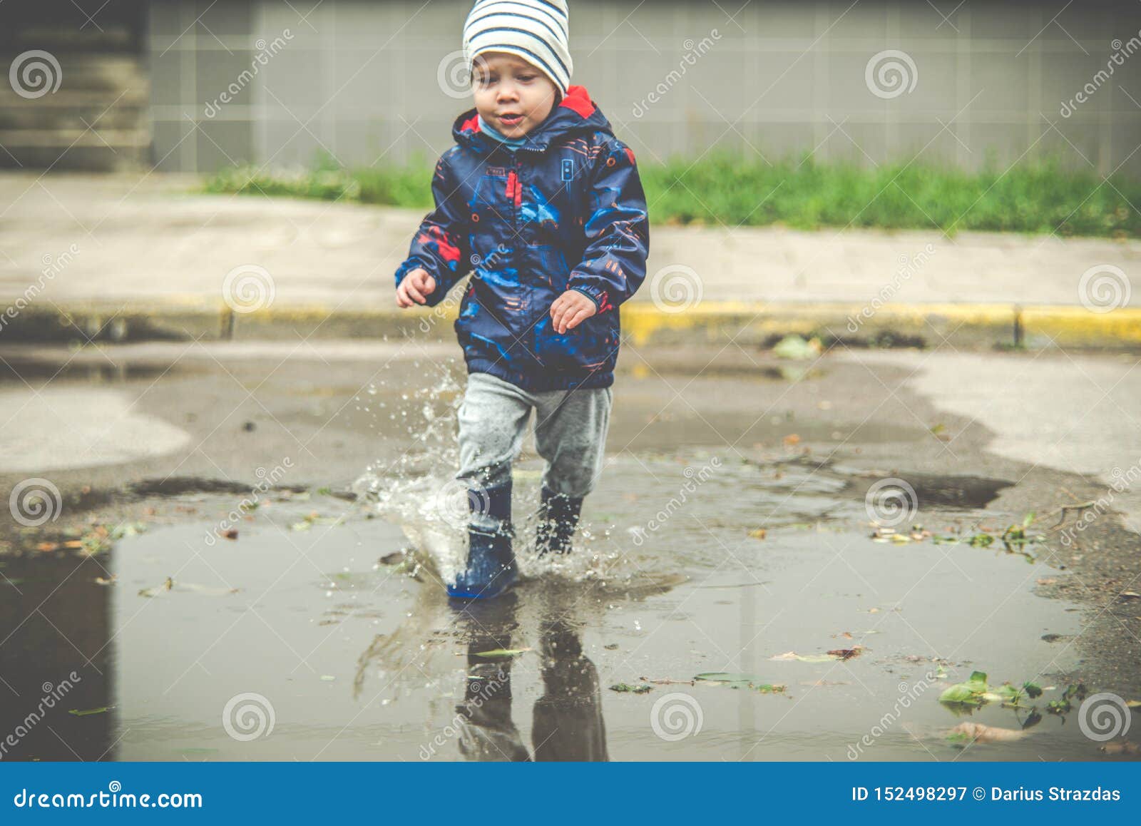 Child splashes puddle stock image. Image of puddle, summer - 152498297