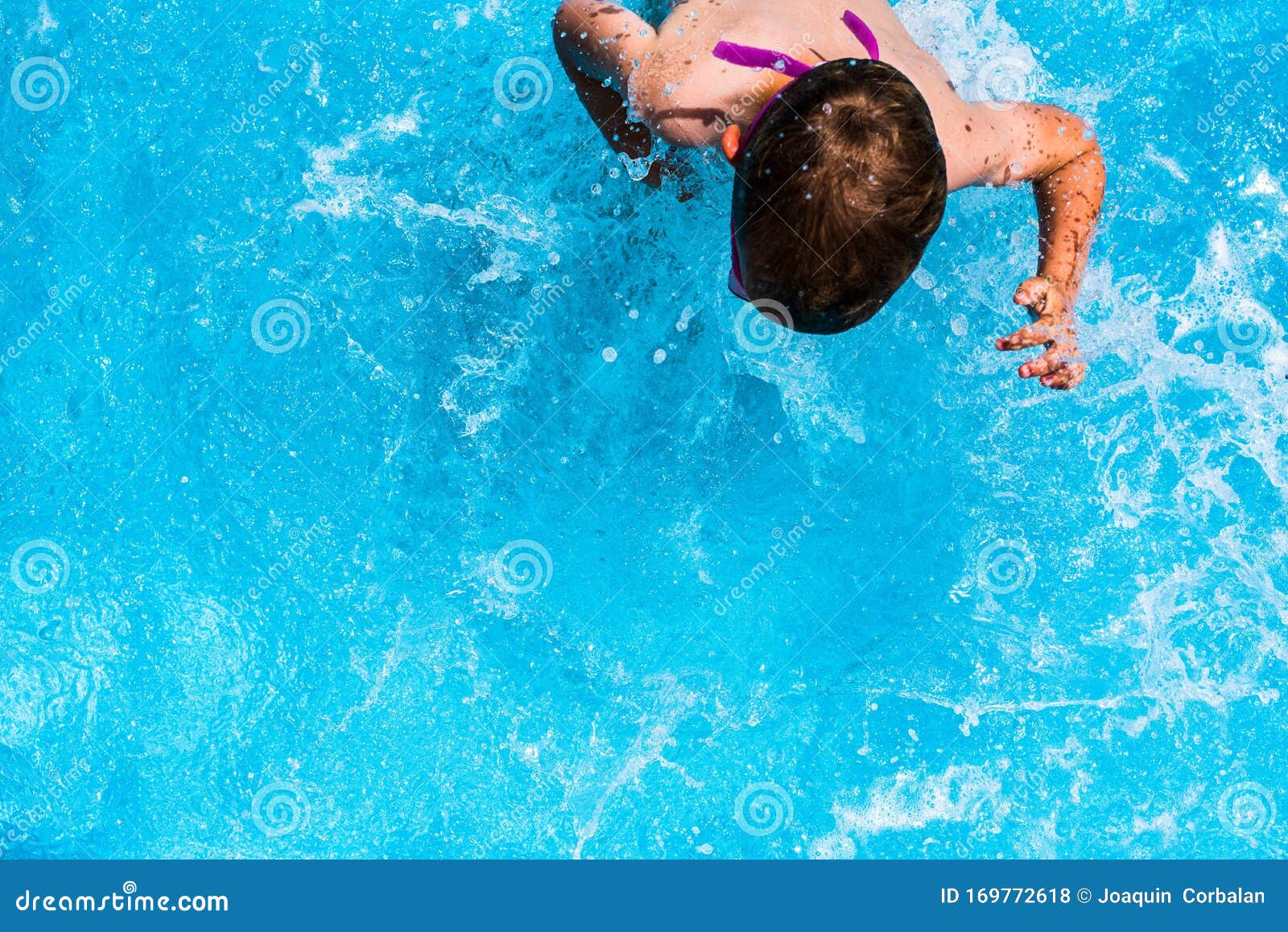Child Splashing in the Cool Water of a Pool in Summer Stock Photo ...