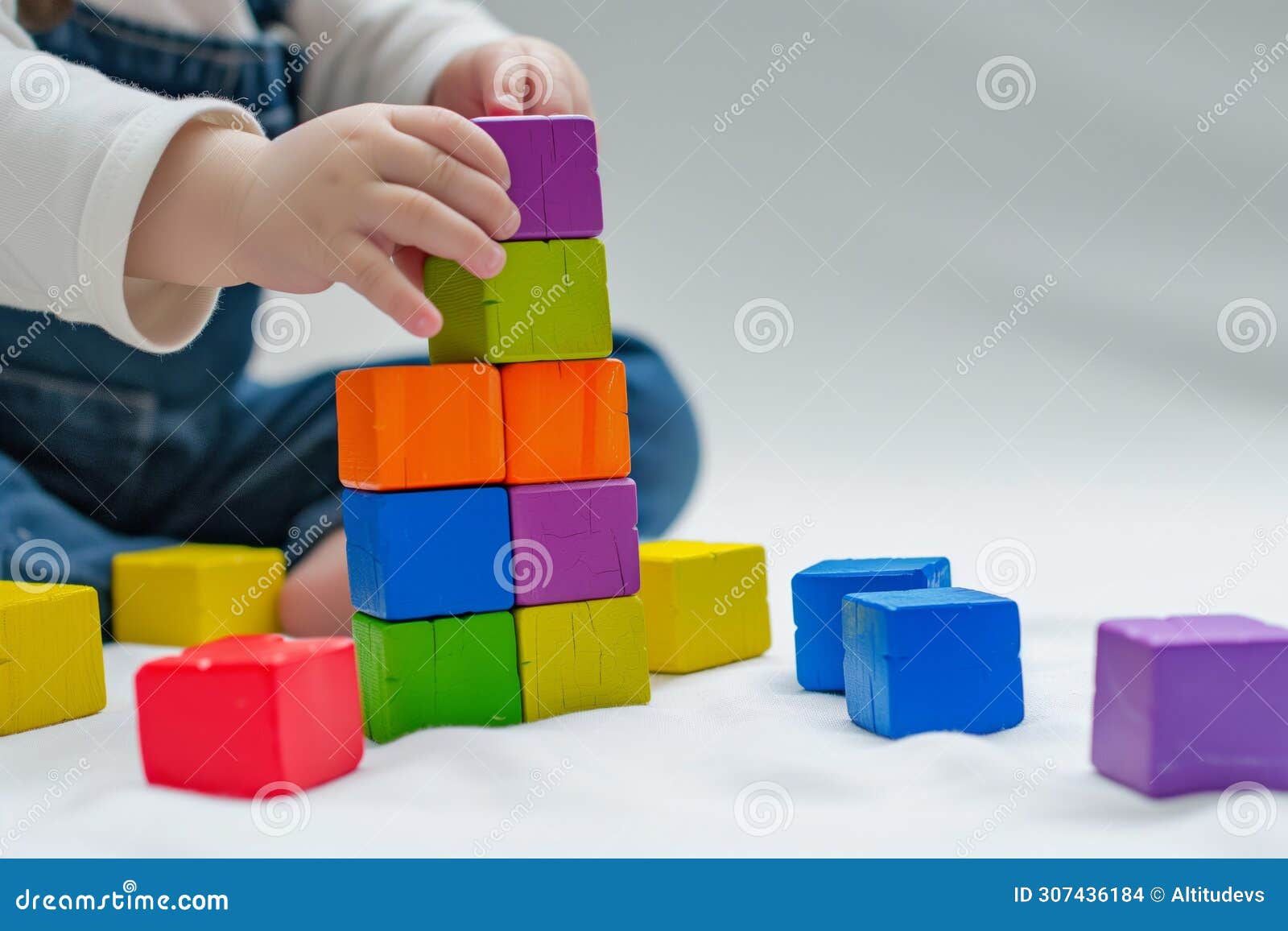 Child Stacking Colorful Blocks Against White Backdrop Stock ...