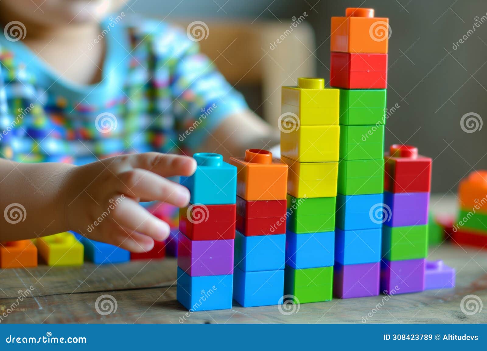 Child Stacking Colorful Toy Bricks To Form an Upward Bar Graph Stock ...
