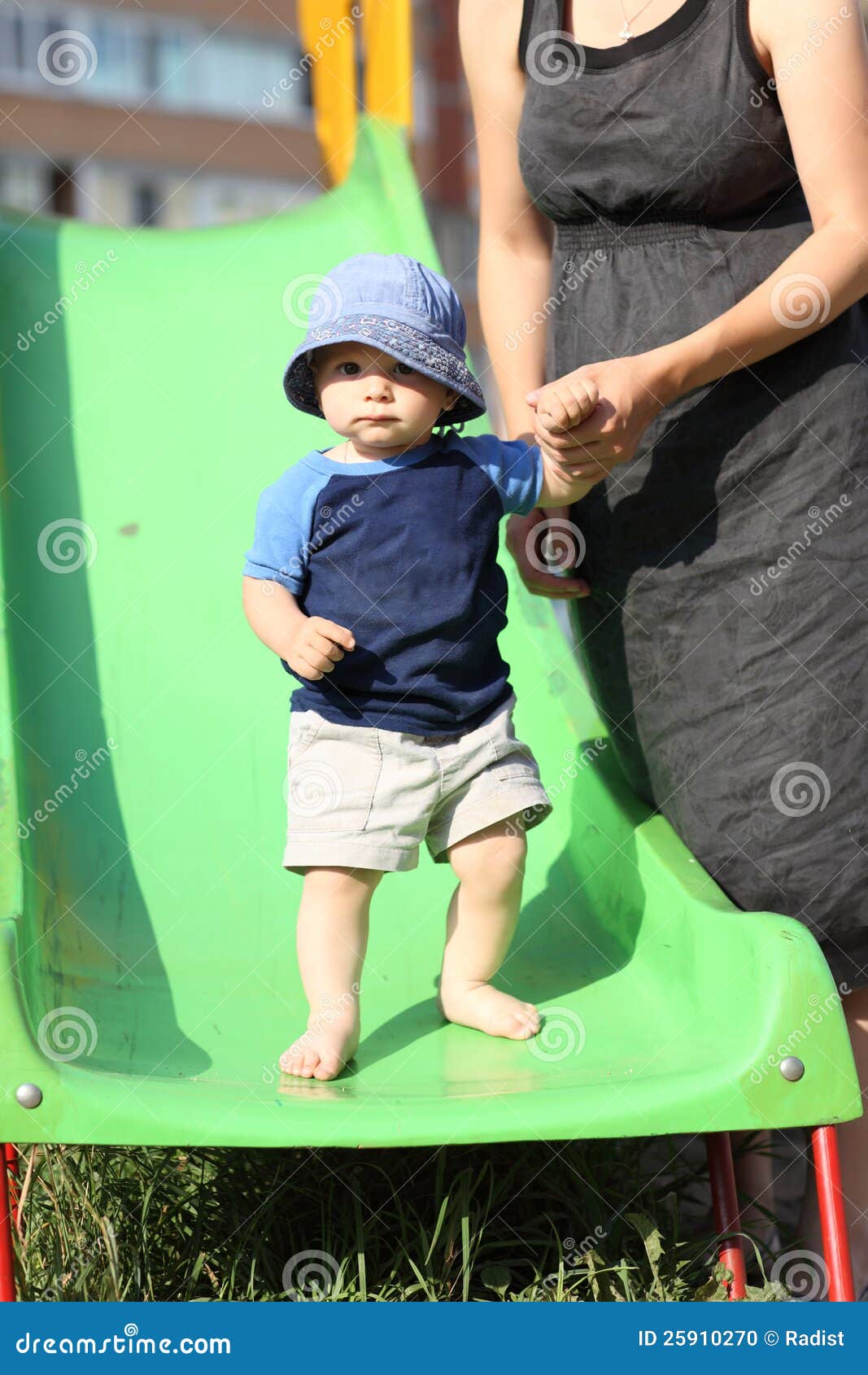 Child standing on slide stock photo. Image of family - 25910270