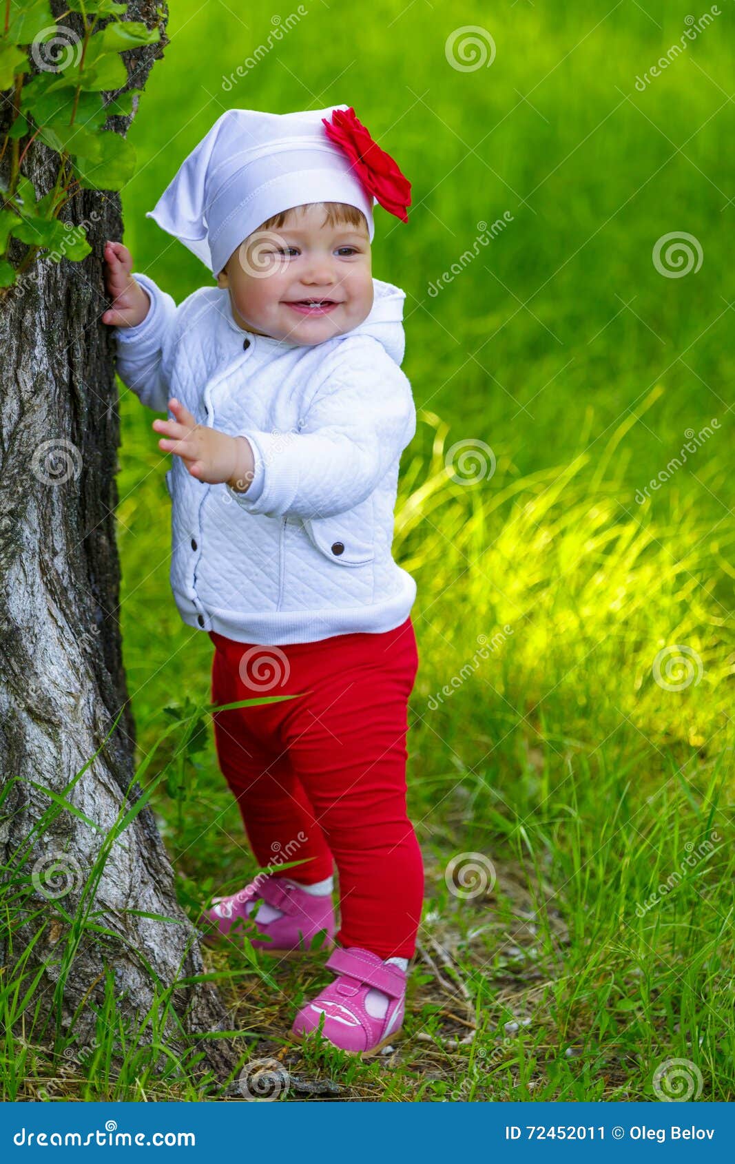 Child stands near a tree stock image. Image of spring - 72452011