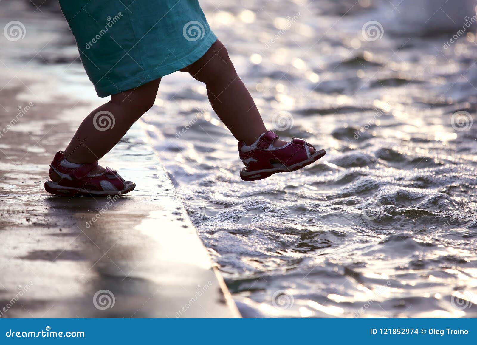 Child steps into the water stock photo. Image of risk - 121852974