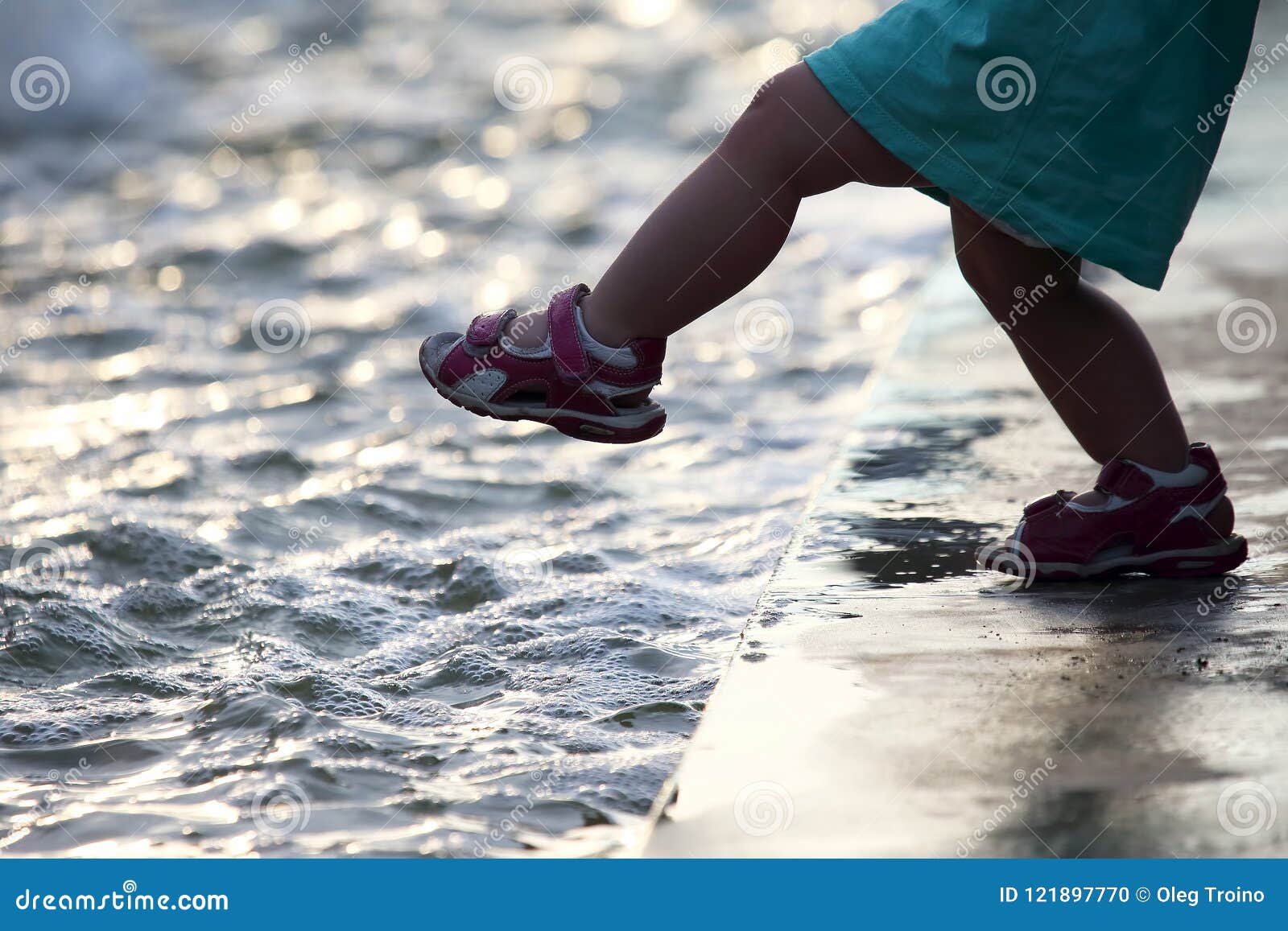 Child steps into the water stock photo. Image of lake - 121897770