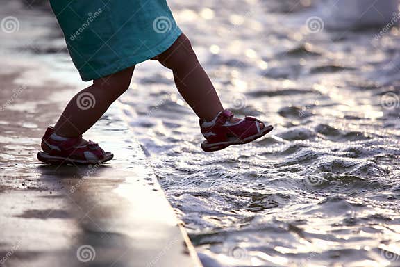 Child steps into the water stock image. Image of steps - 121897809