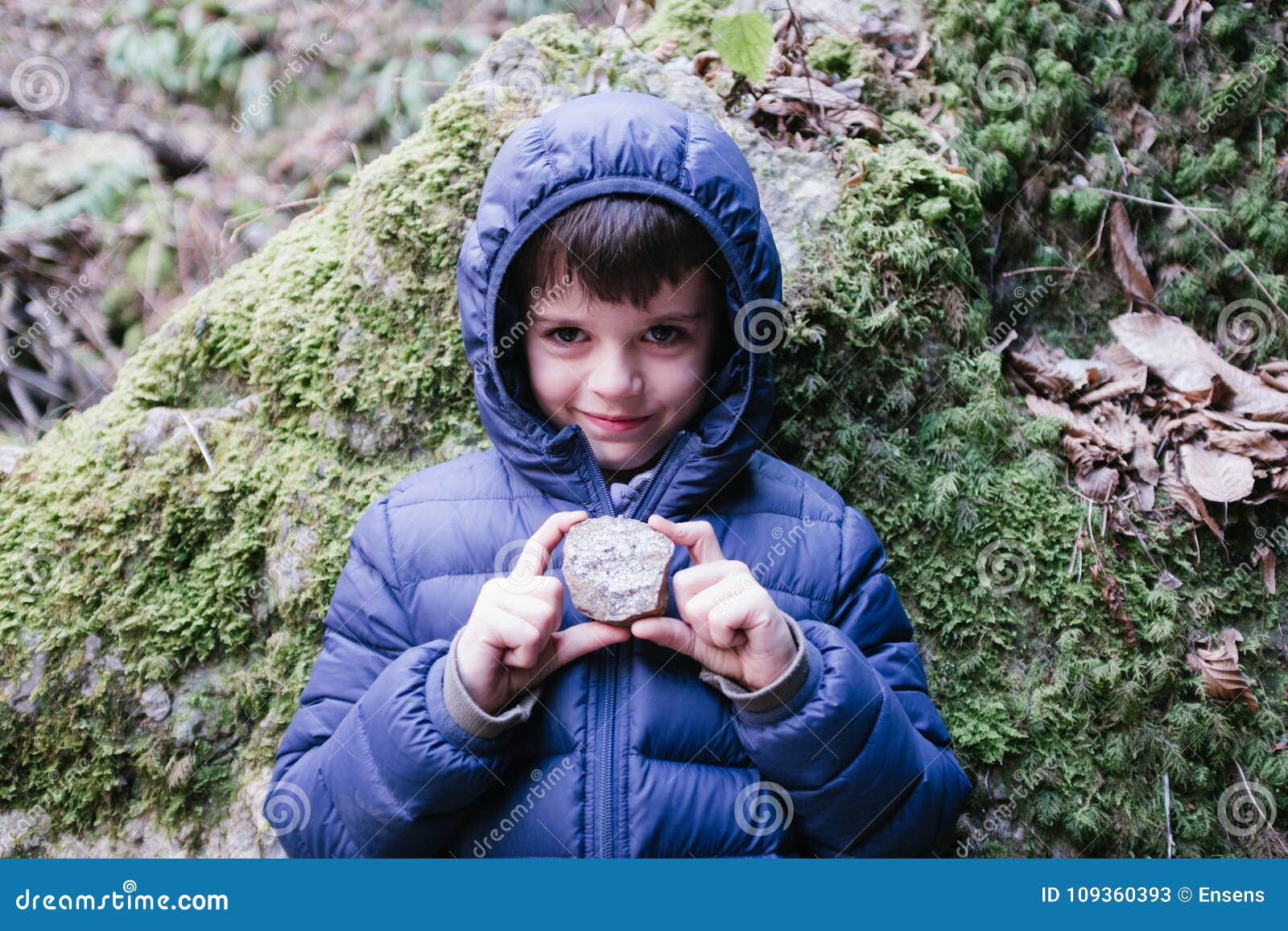 Child with stone in hand stock image. Image of life - 109360393