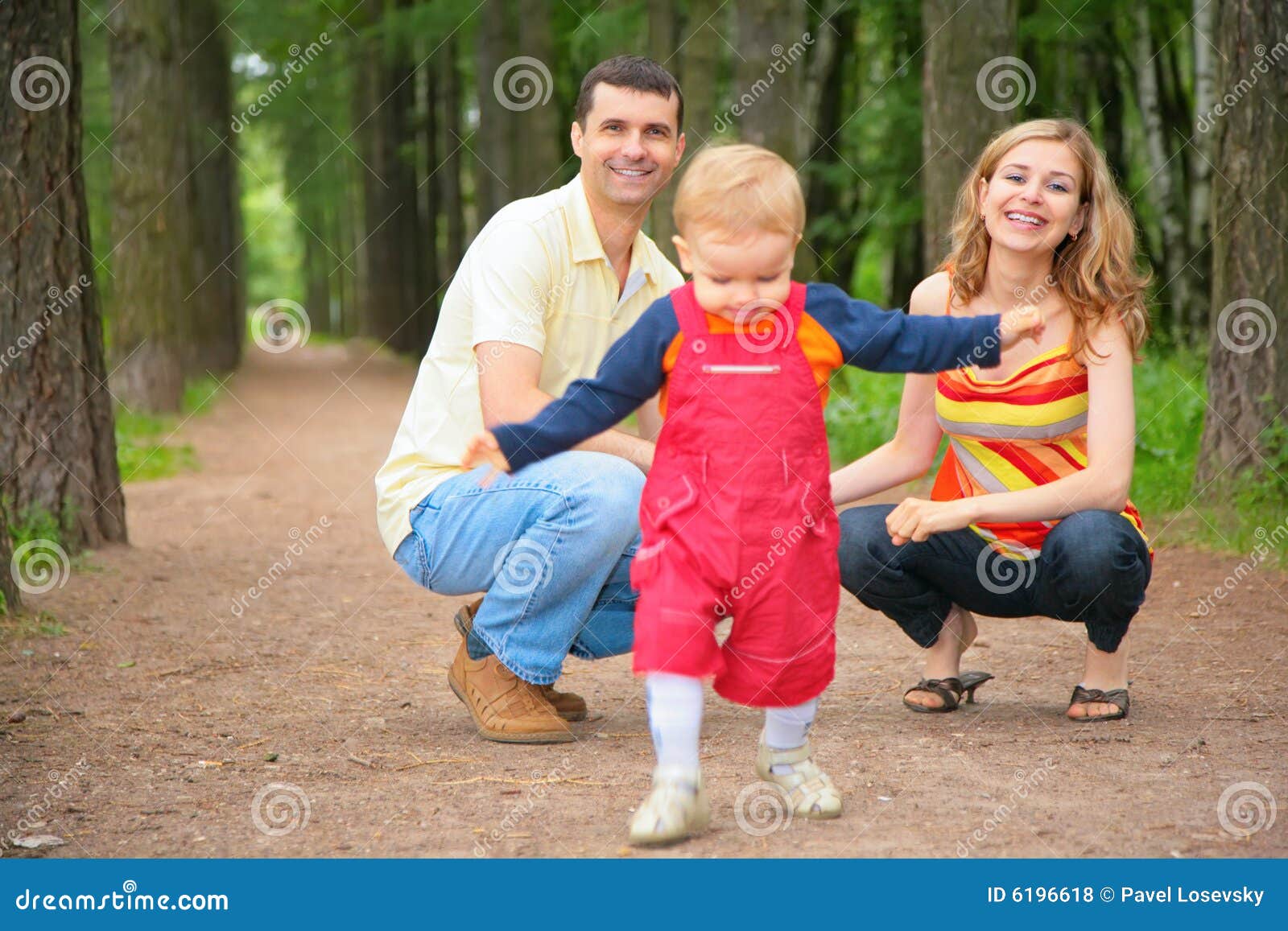 Child Studies To Go with Parents in Park Stock Photo - Image of casual ...