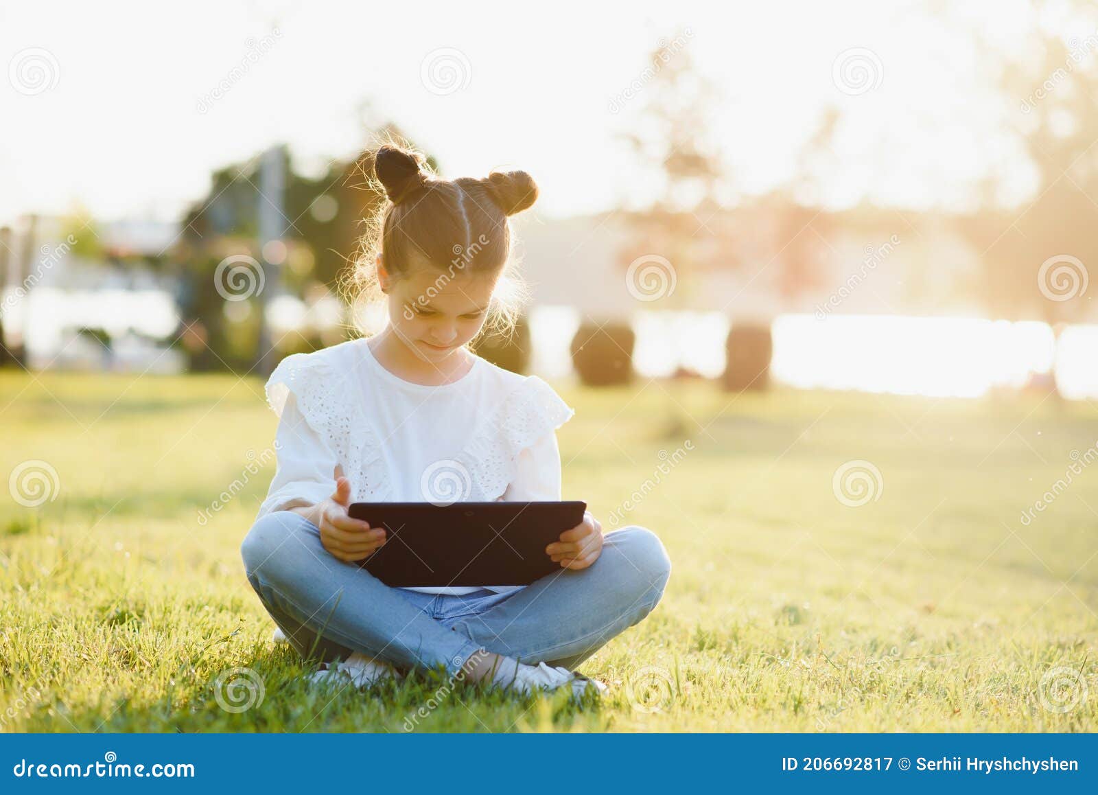 Child with Tablet Pc Outdoors. Little Girl on Grass with Computer Stock ...