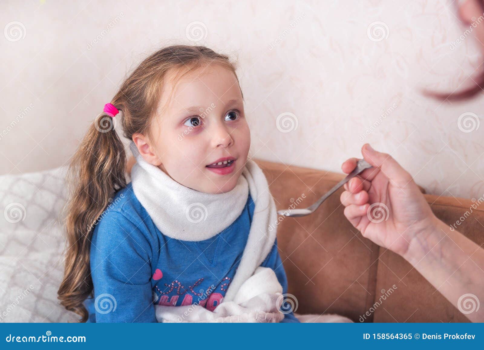 Child Taking Medicine. Sick Girl with Scarf Lying on Bed Stock Image ...