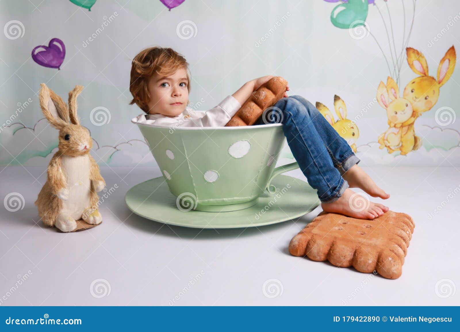 Child in a Tea Cup with Some Biscuits Stock Photo - Image of table ...