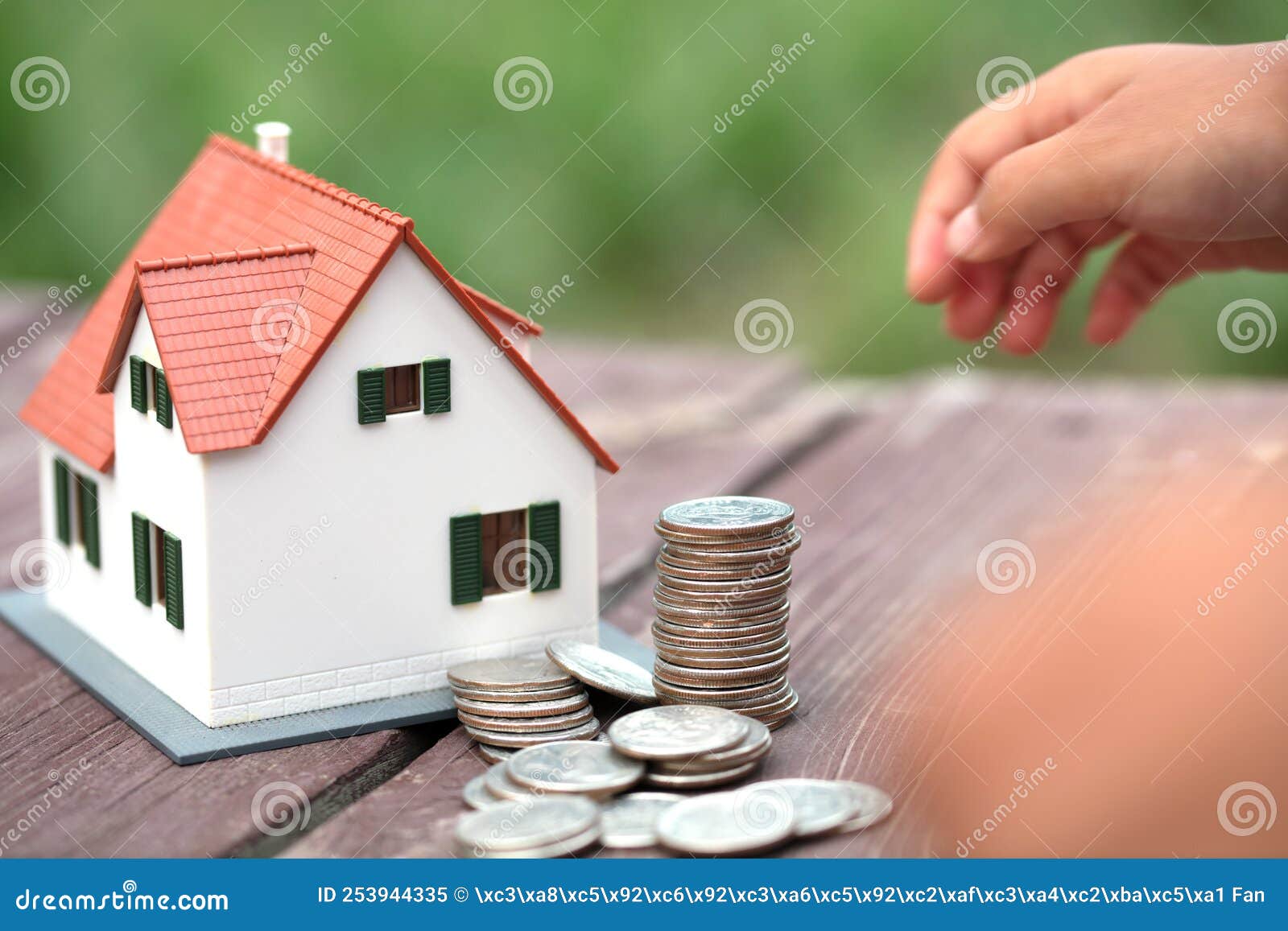 A House Model and CoinsThe Child Threw Coins into the Model House Stock ...