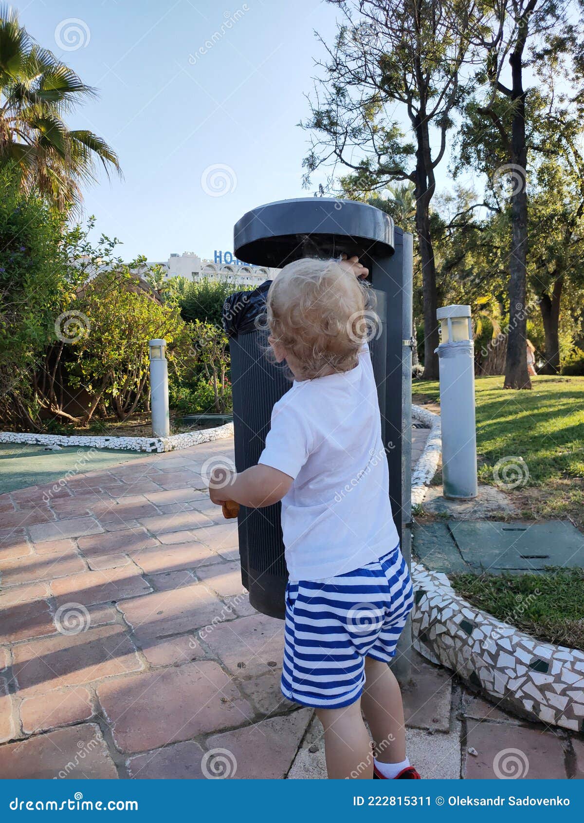 Child Throws Garbage in a Trash Can in the Park Stock Image - Image of ...