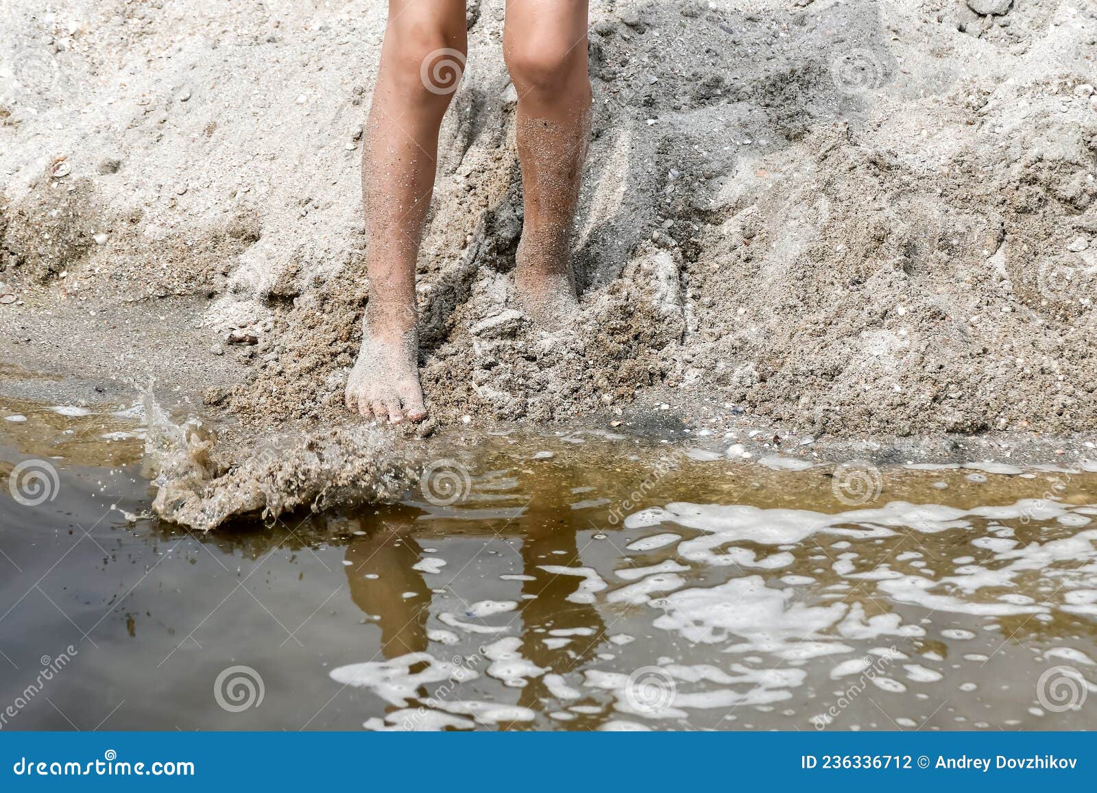 A Child Throws Sand into a Small Muddy Lake Stock Photo - Image of ...