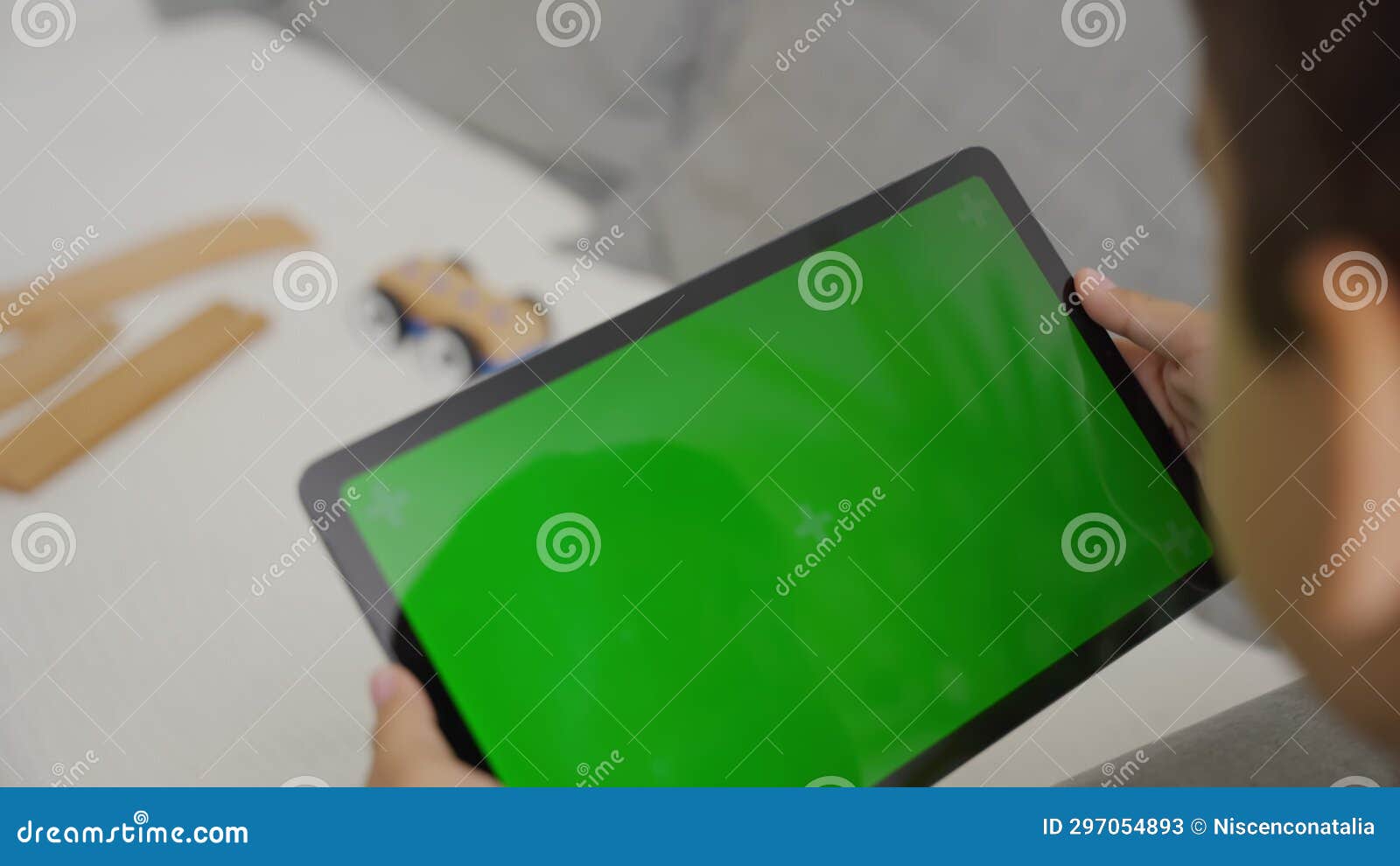 Child Tilting To the Left and Right a Tablet with Green Screen, Side ...