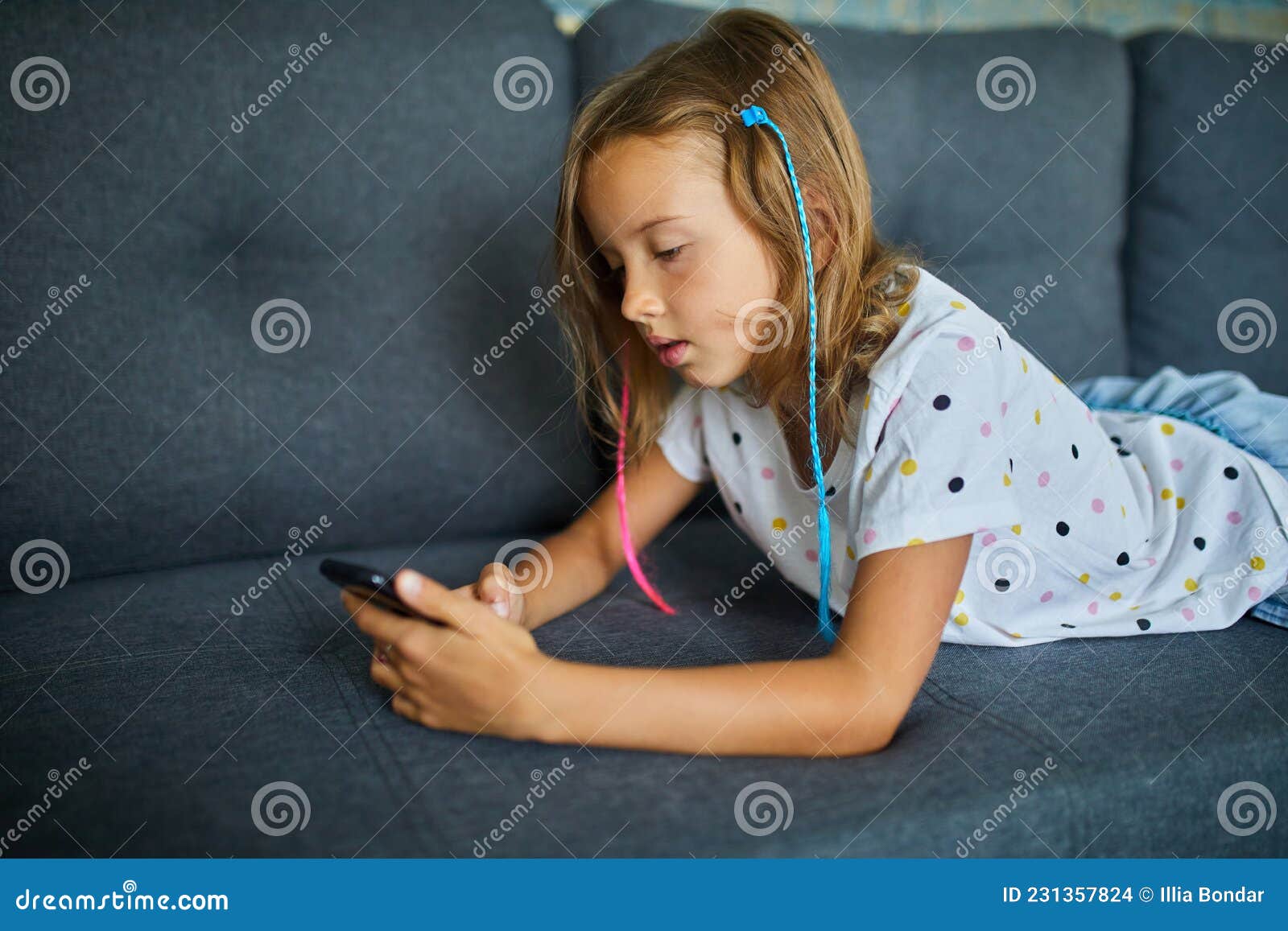 Child Using Cellphone on the Sofa in Modern and Bright Apartment Stock ...