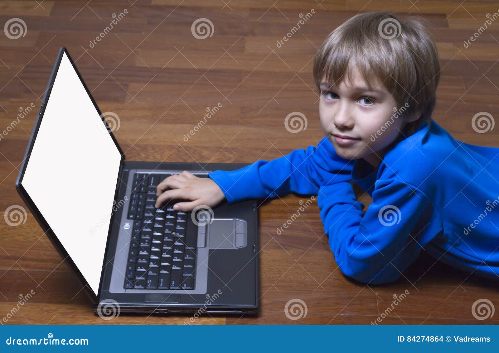 Child Using Laptop PC Lying on Wooden Floor. Top View. Education ...