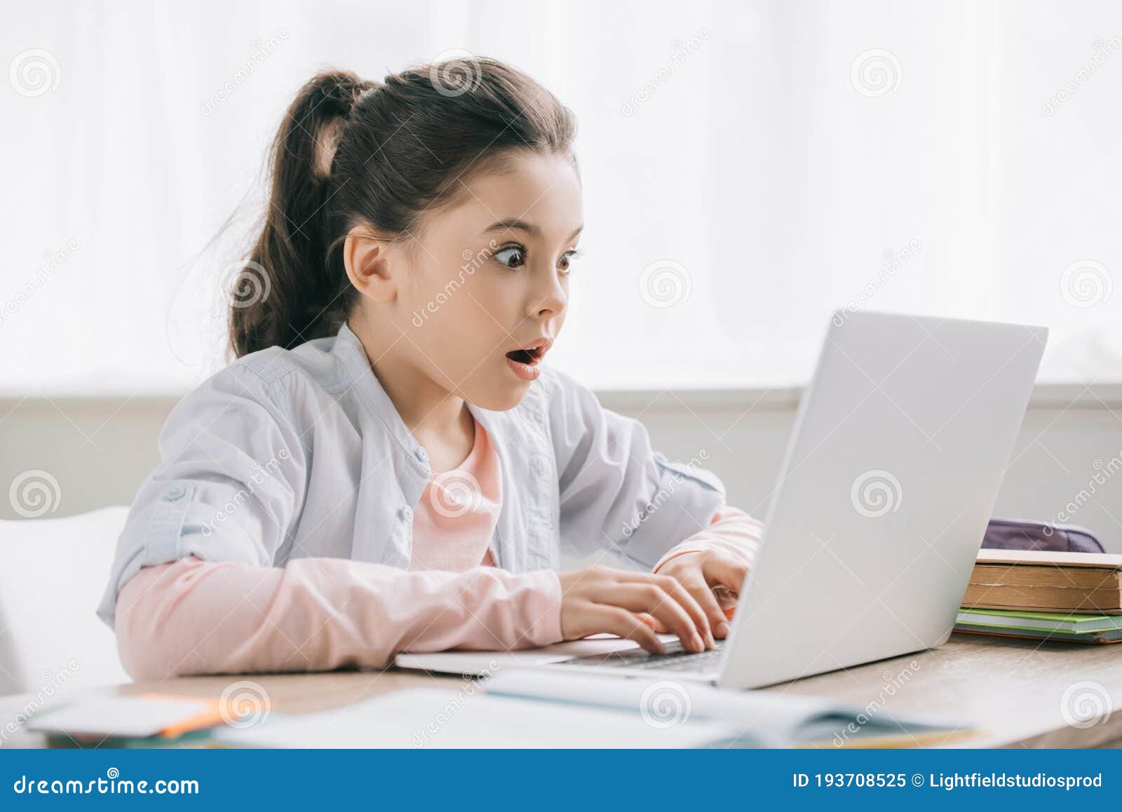 Child Using Laptop while Sitting at Desk and Doing Schoolwork at Home ...