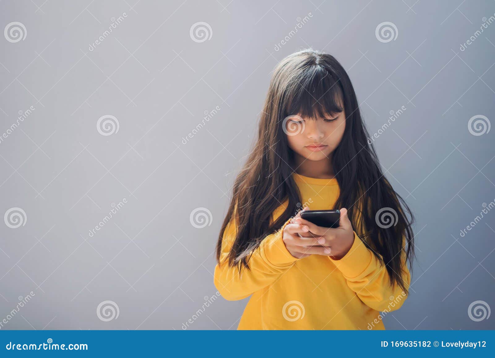 Child using mobile on blue stock photo. Image of internet - 169635182