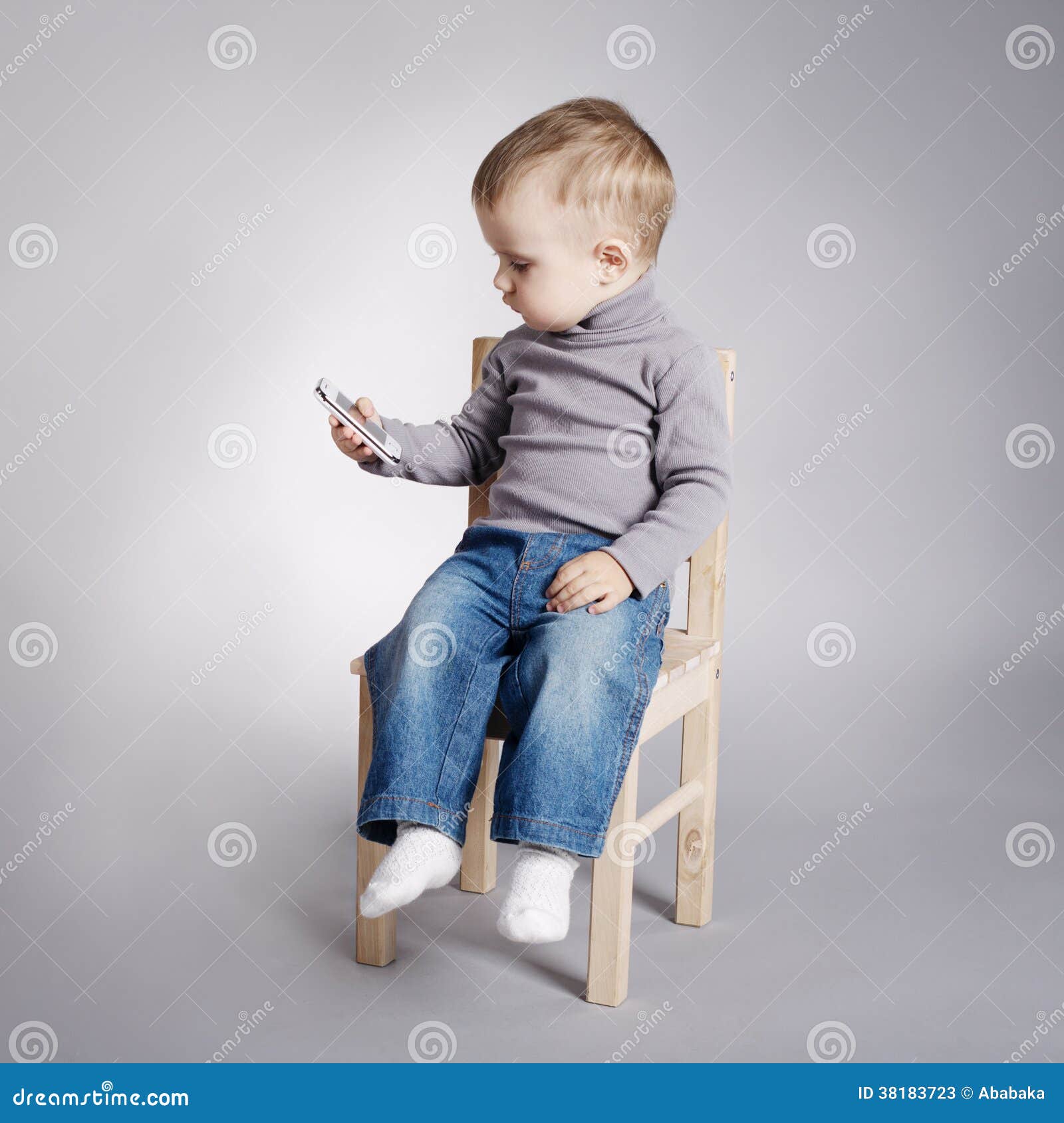 Child using a mobile phone stock image. Image of grey - 38183723