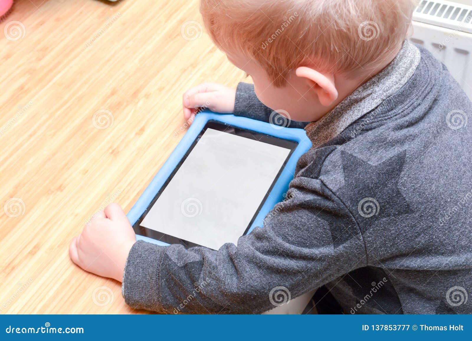 Child Using a Tablet Computer To Learn and Play Games, Model is Young ...