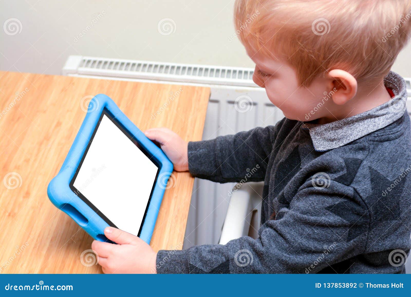 Child Using a Tablet Computer To Learn and Play Games, Model is Young ...