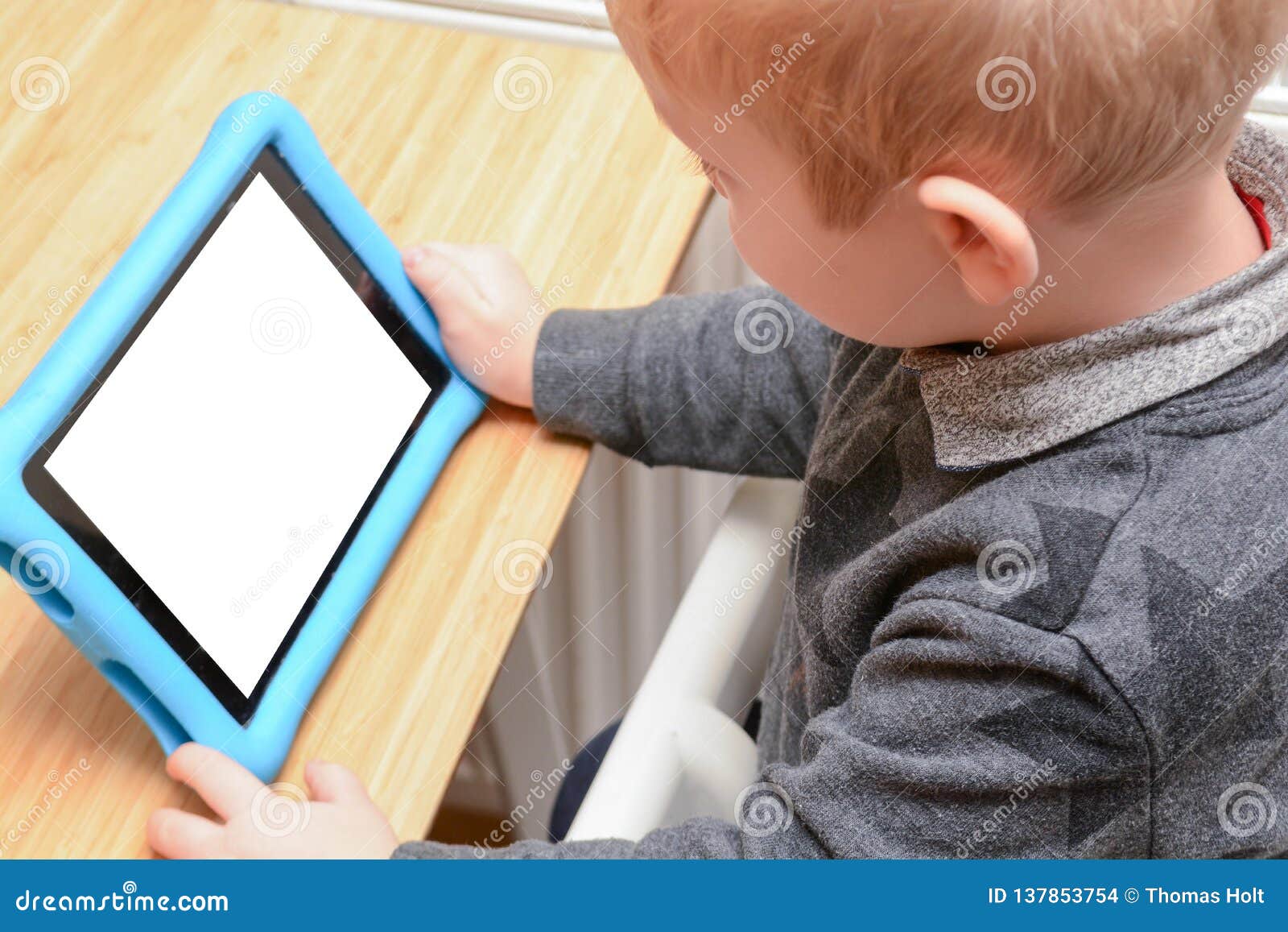 Child Using a Tablet Computer To Learn and Play Games, Model is Young ...