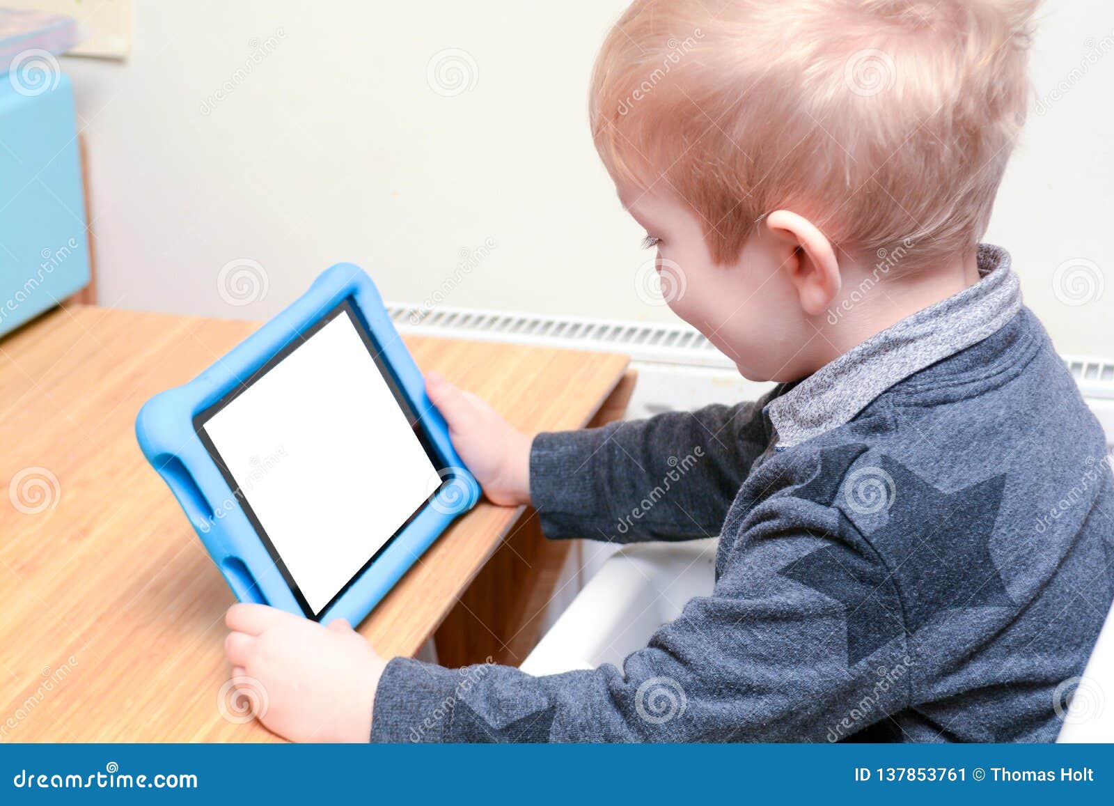 Child Using a Tablet Computer To Learn and Play Games, Model is Young ...