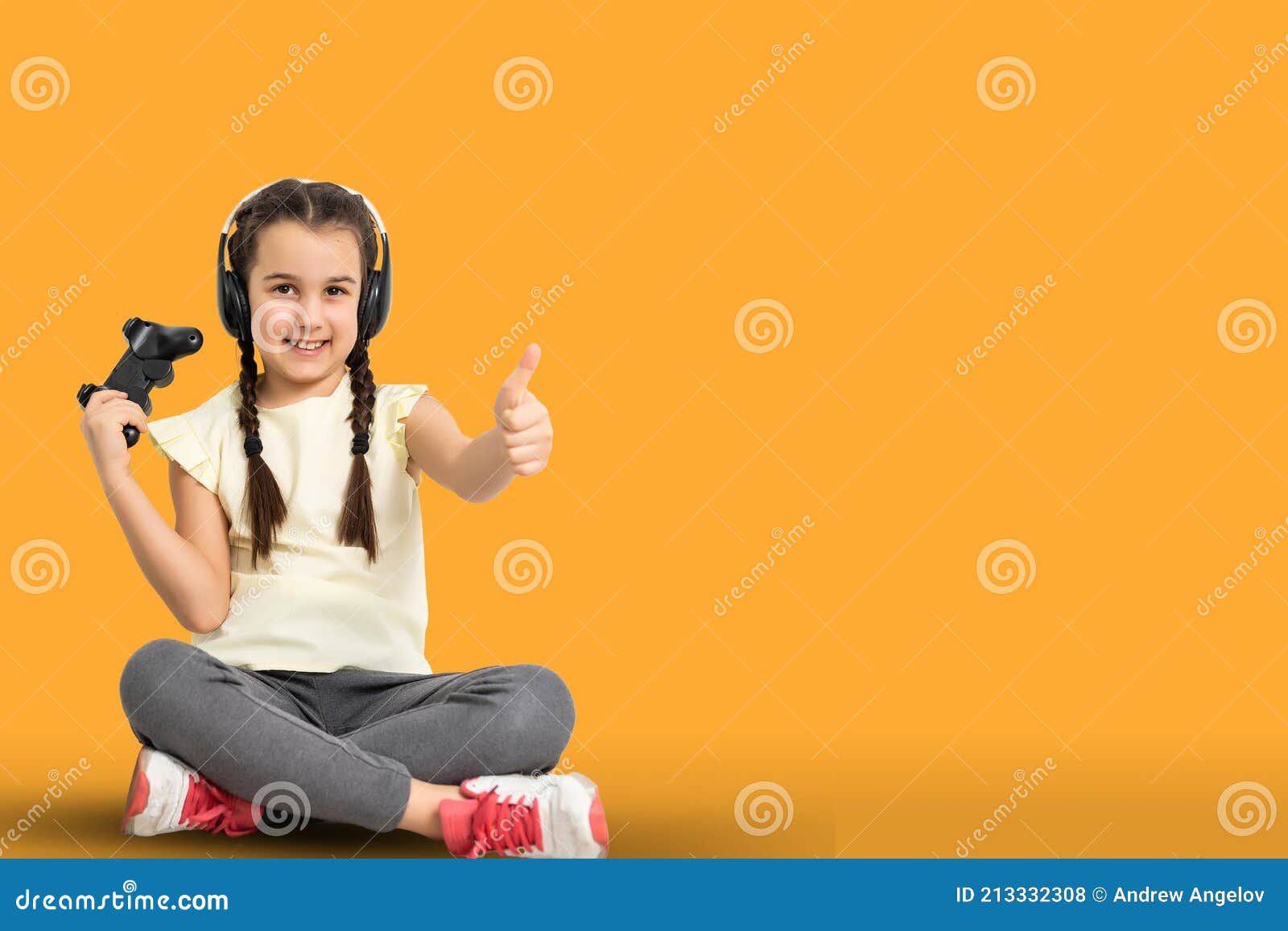 Child Using Video Game Controller. Isolated on Yellow Background Stock ...