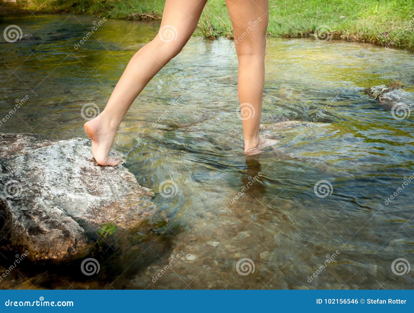 Child Walking Across a Small River with Bare Feet Stock Photo - Image ...