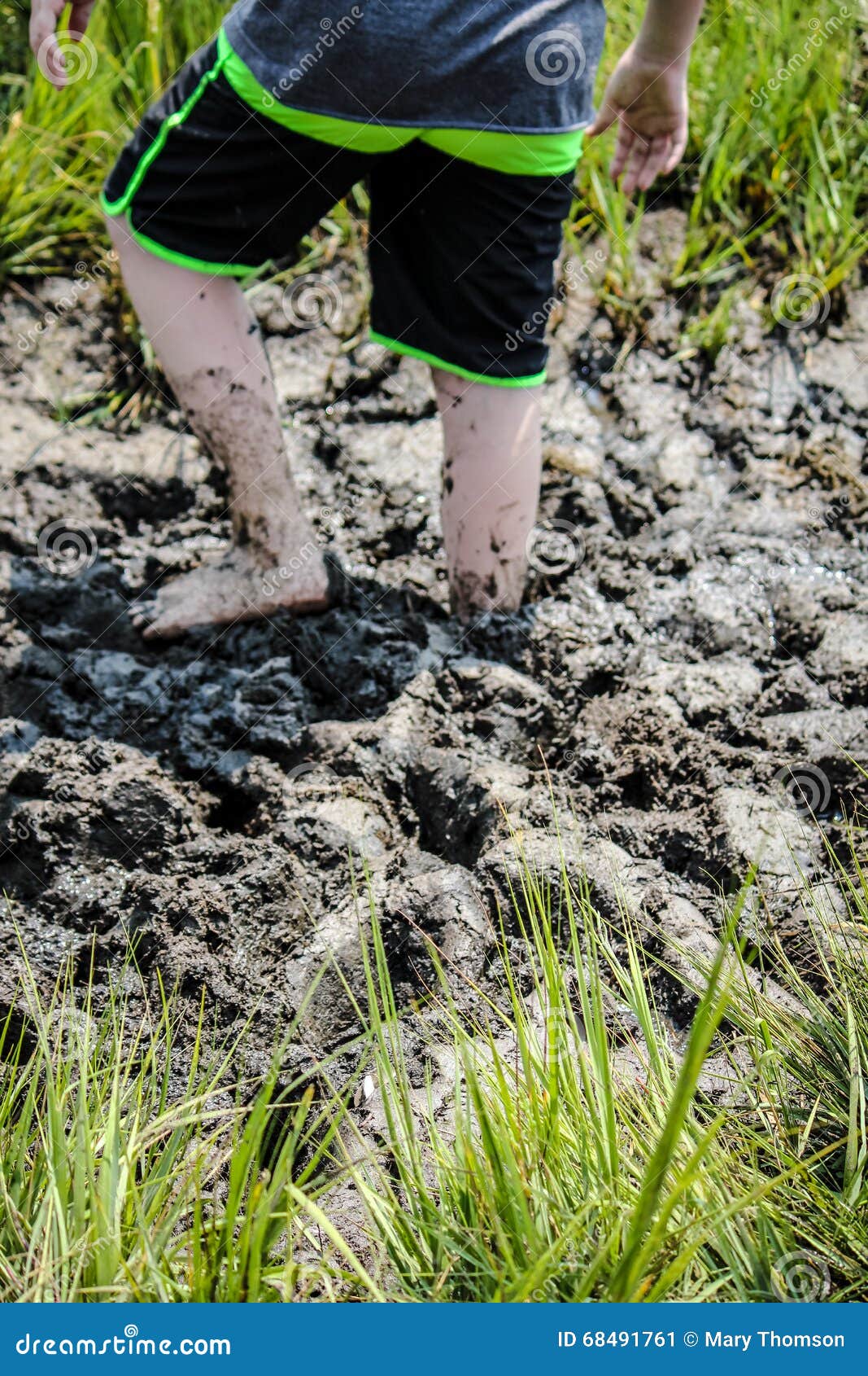 Child Walking through Muddy Marsh Stock Image - Image of wetlands ...